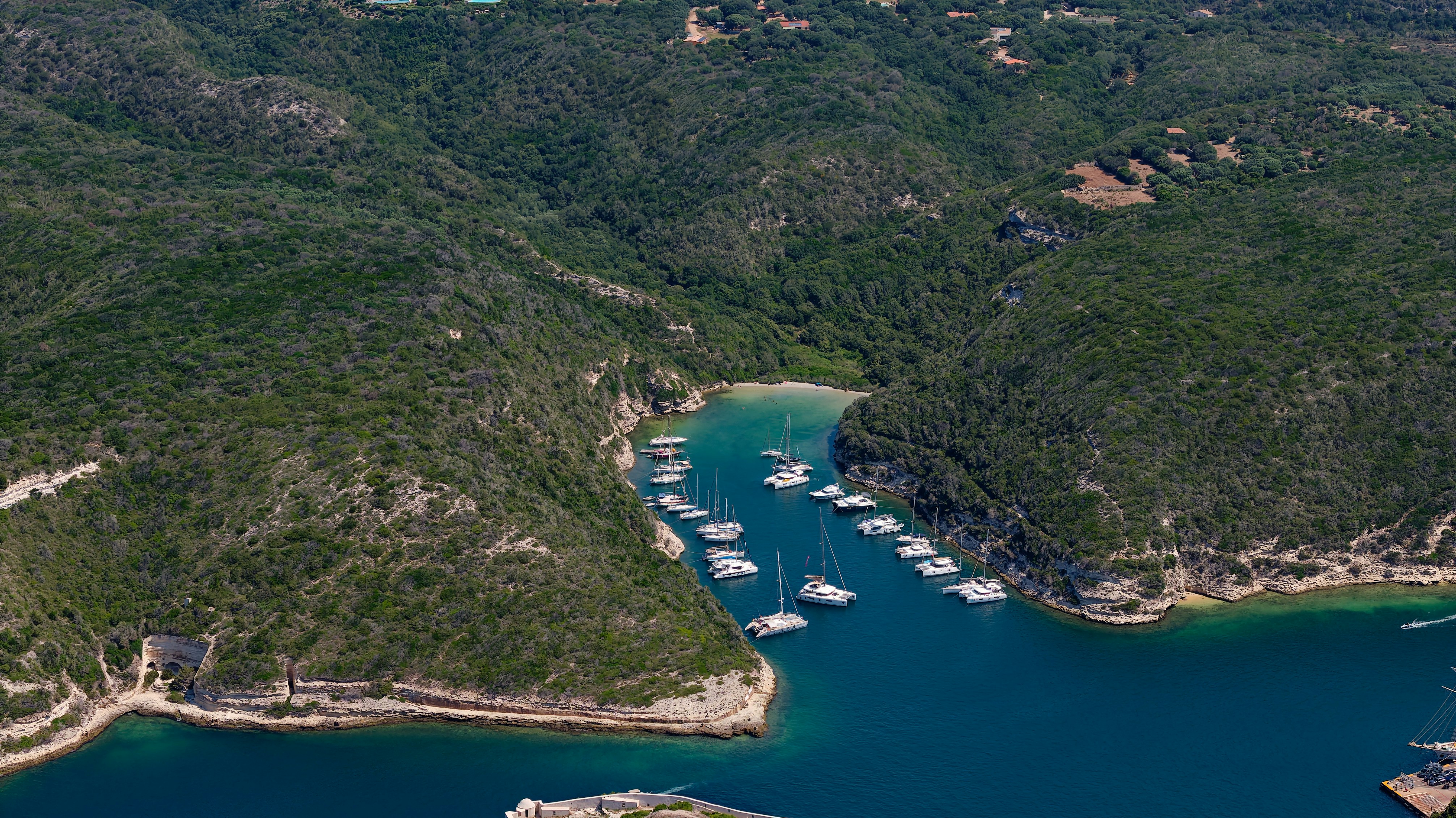 Hidden Marina Crescent: Boats Nestled in Emerald Caldera