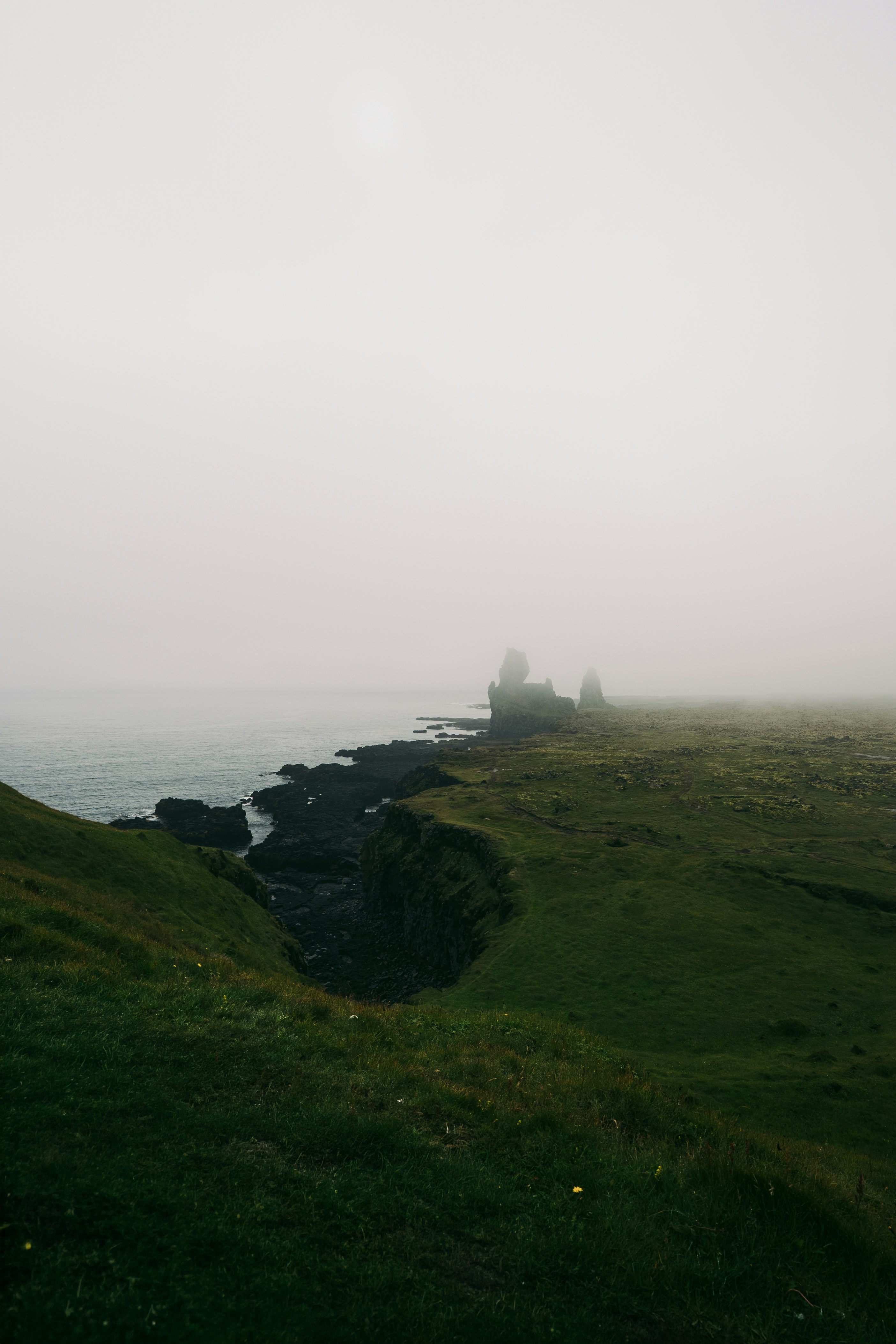 Mistbound Cliffs: Sea Stack silhouettes emerge from the fog