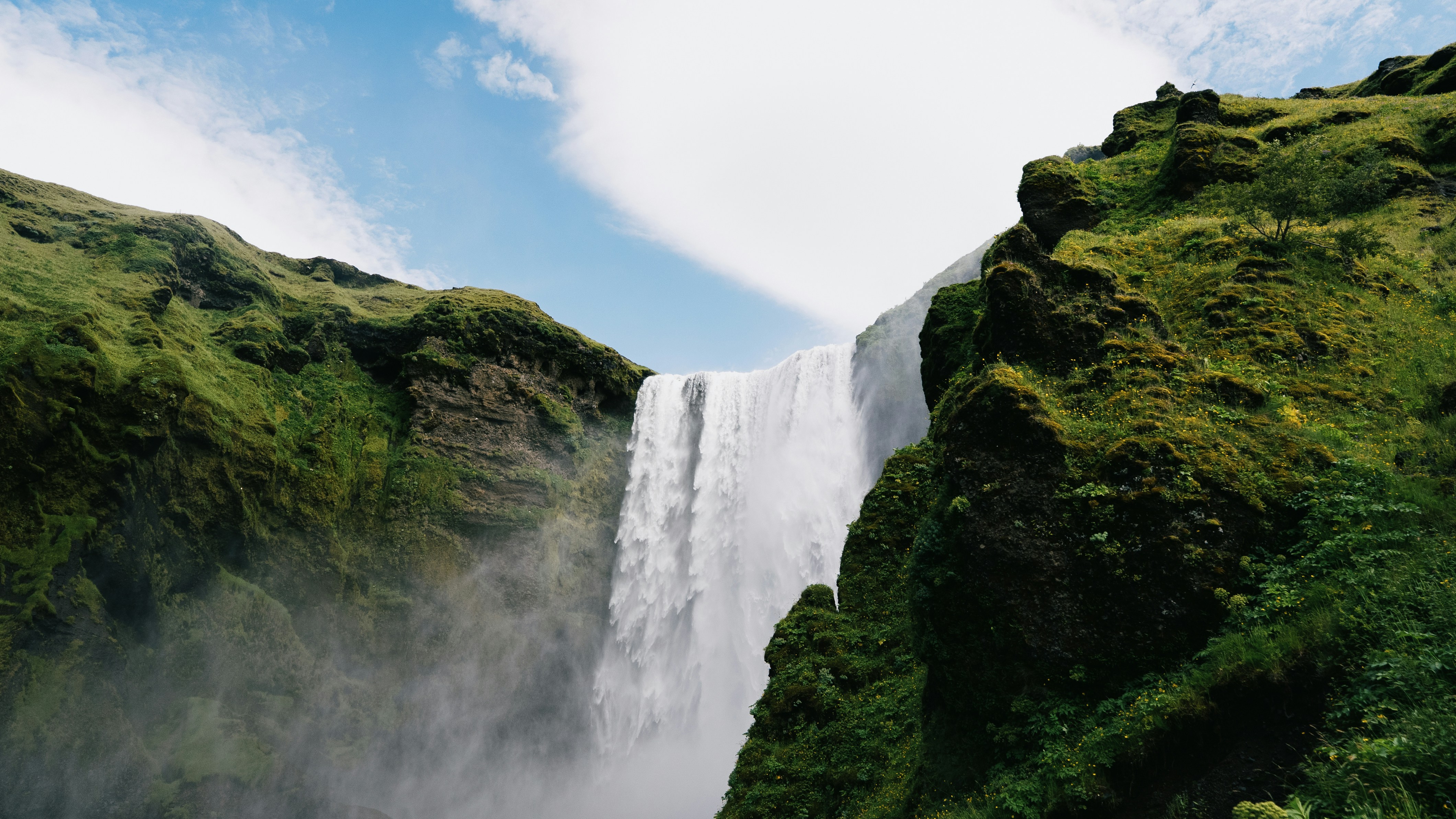 Harnessing the Veil: A Tall Cascade Between Green Cliffs
