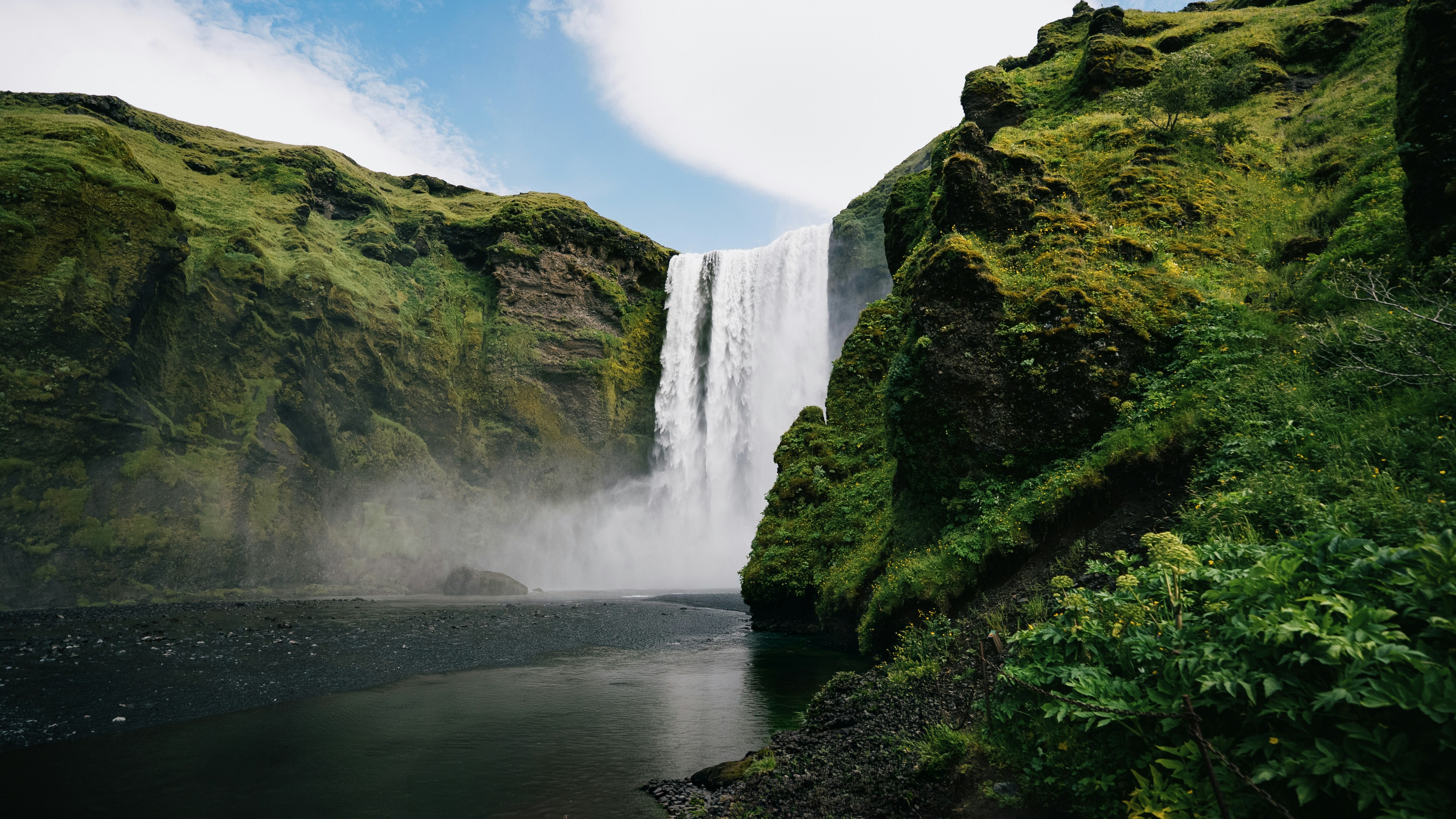 Cascading Veil: A Lush Canyon Waterfall Crowned by Mossy Cliffs