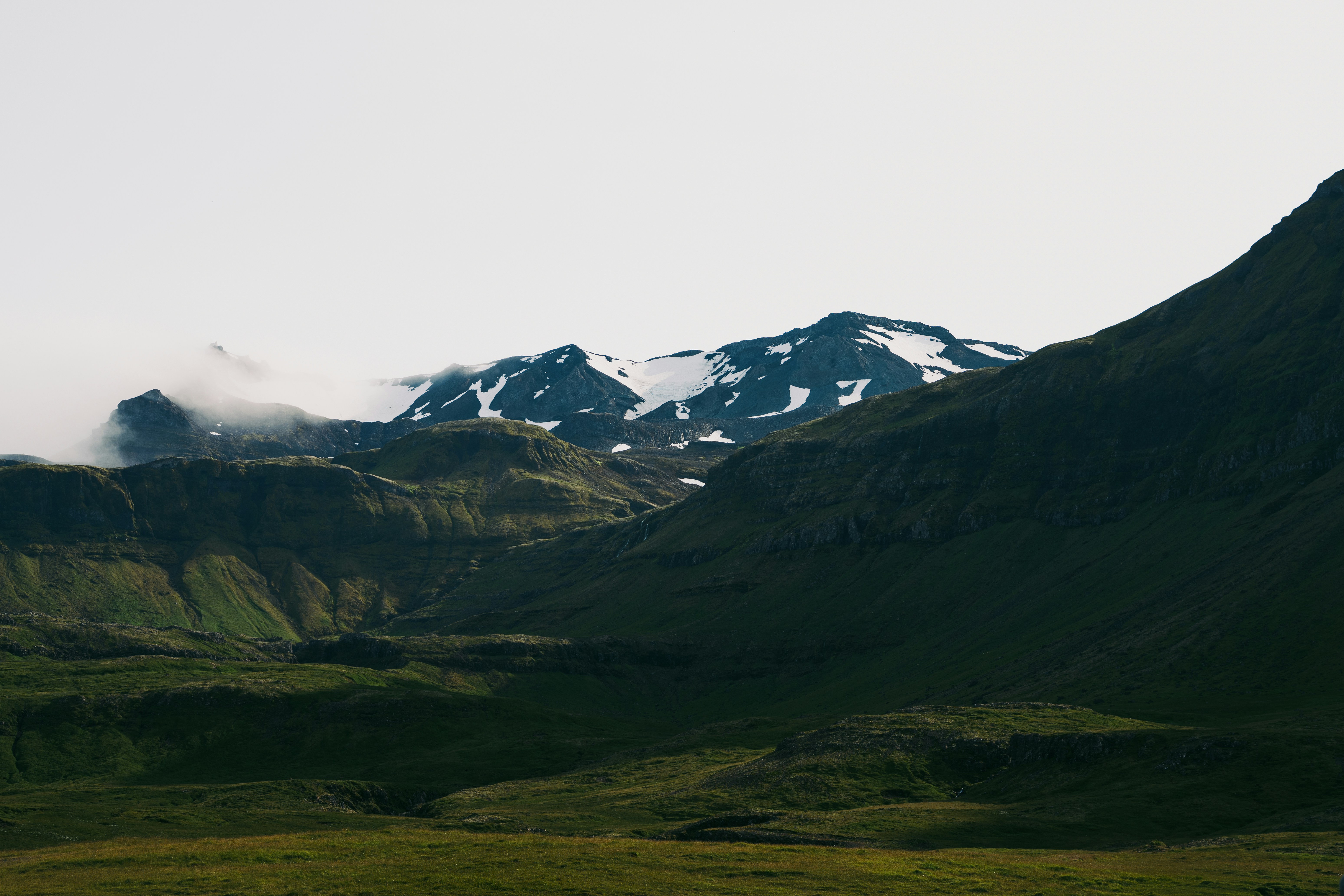 Sunlit Valleys Beneath Snow-dusted Peaks