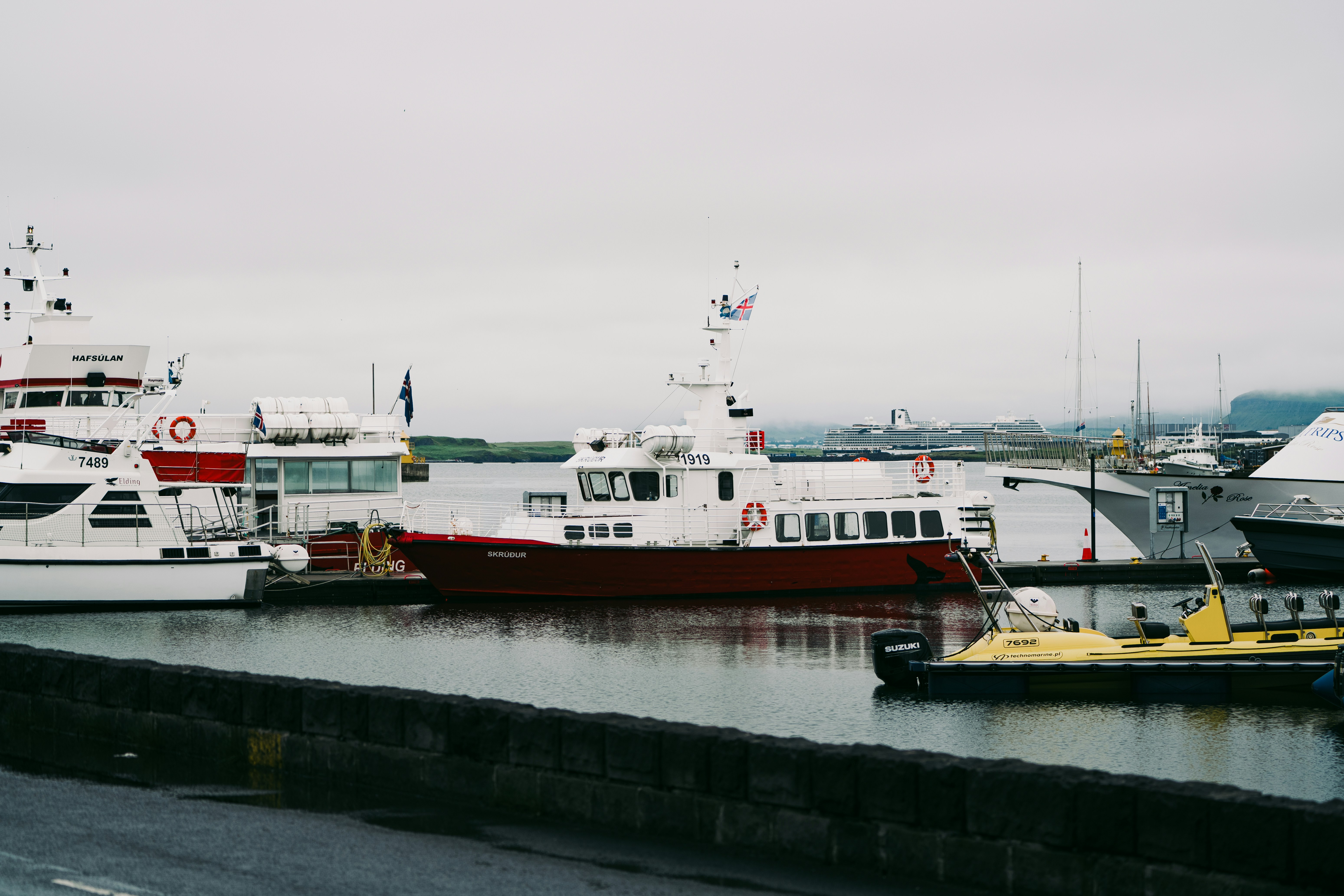 Harbor Lineup: Vessels at Dusk along a Quiet Dock