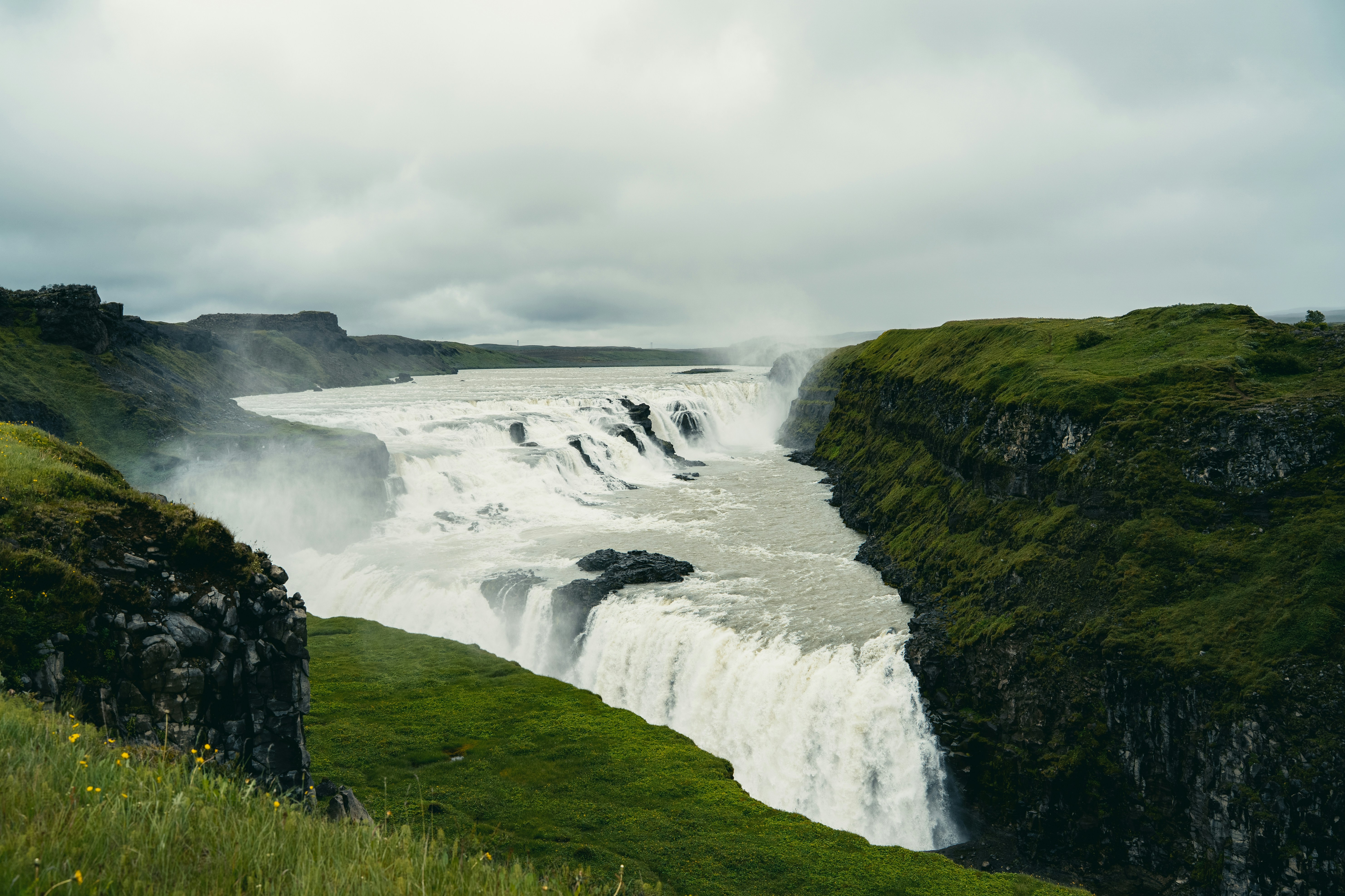 Mid‑Valley Cascade: A Quiet Gloom Over the Distant Falls