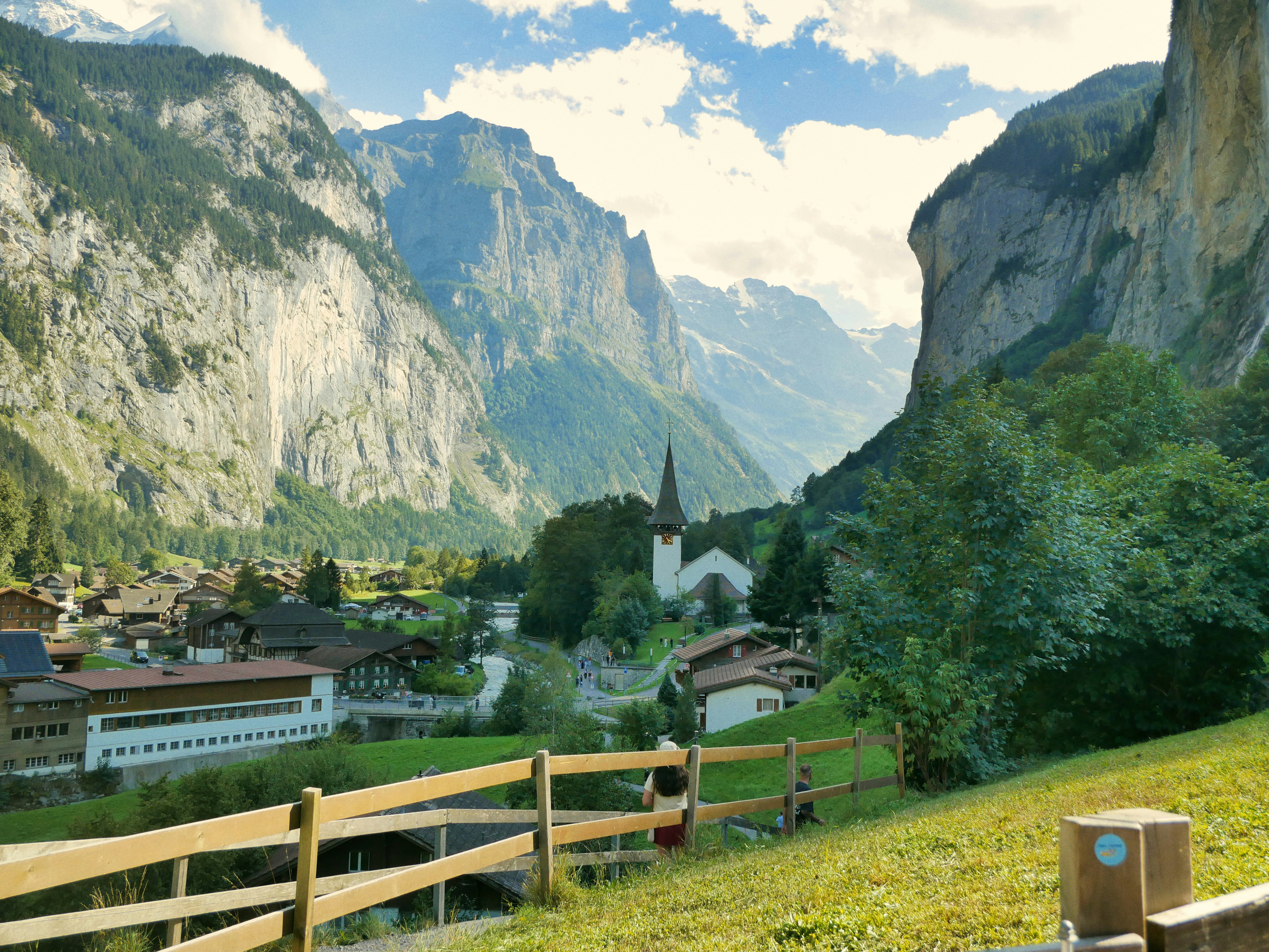 Valley Village Beneath Towering Alpine Cliffs