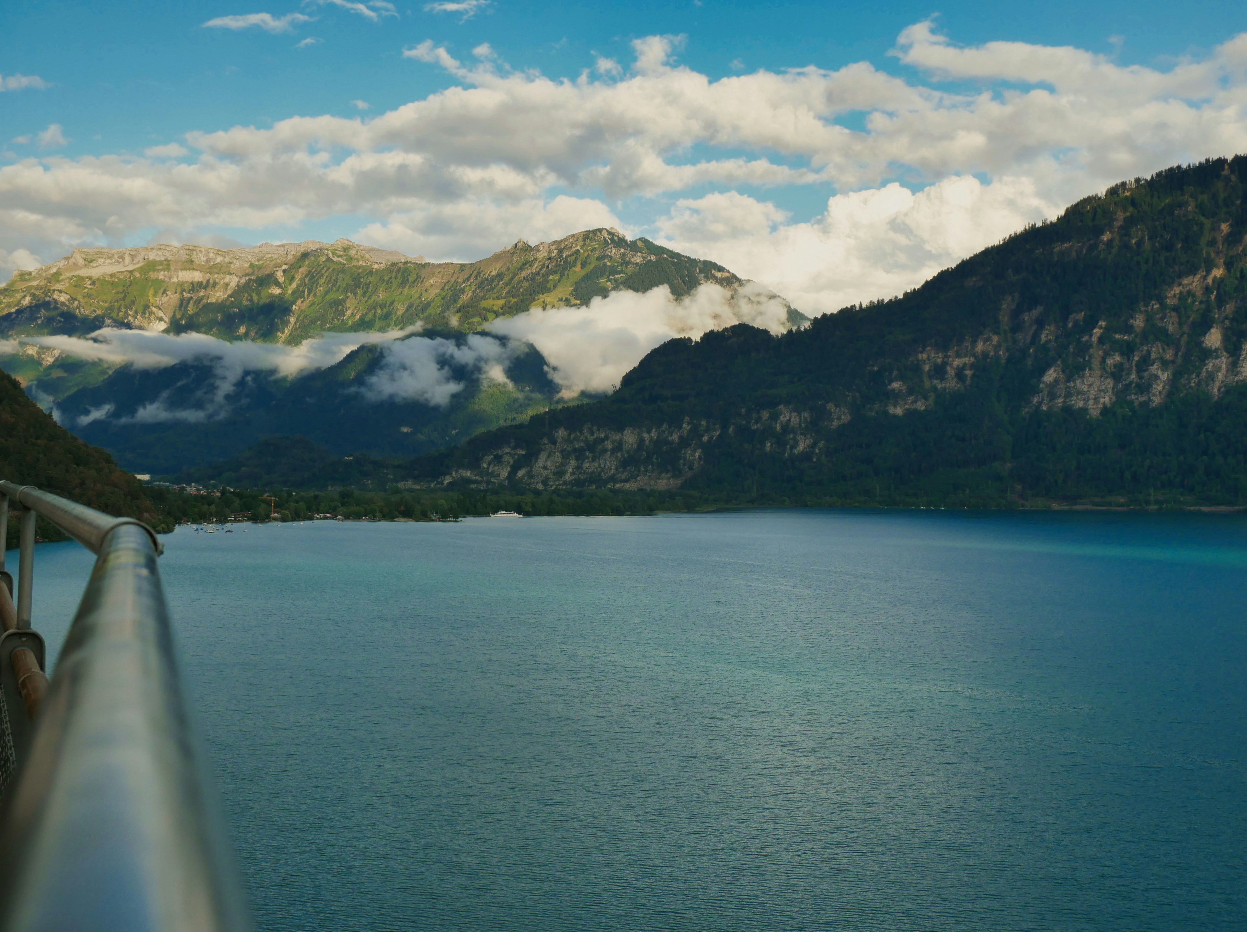 Quiet Fjord from the Rail: A Serene Lake Surrounded by Misty Peaks