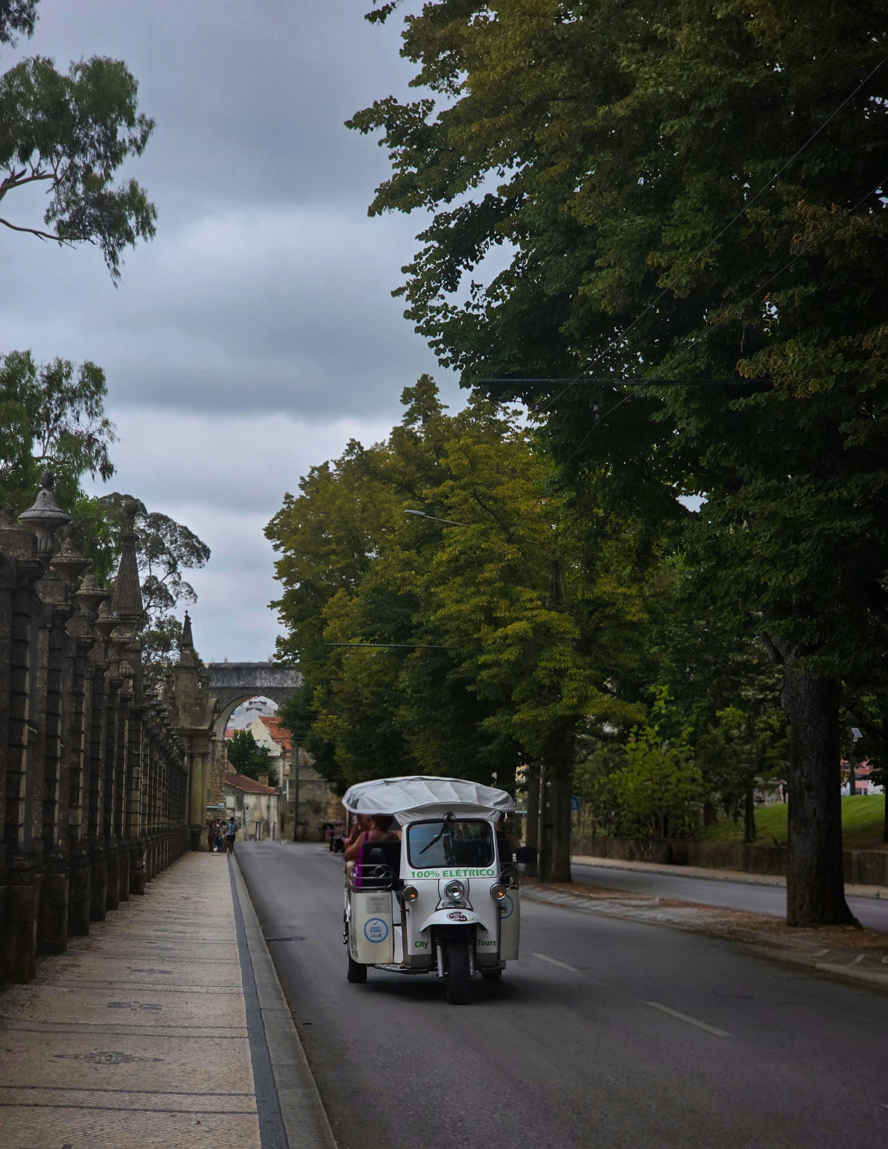 Pedicab Advance: A Trolley’s Journey Under a Cloudy Boulevard
