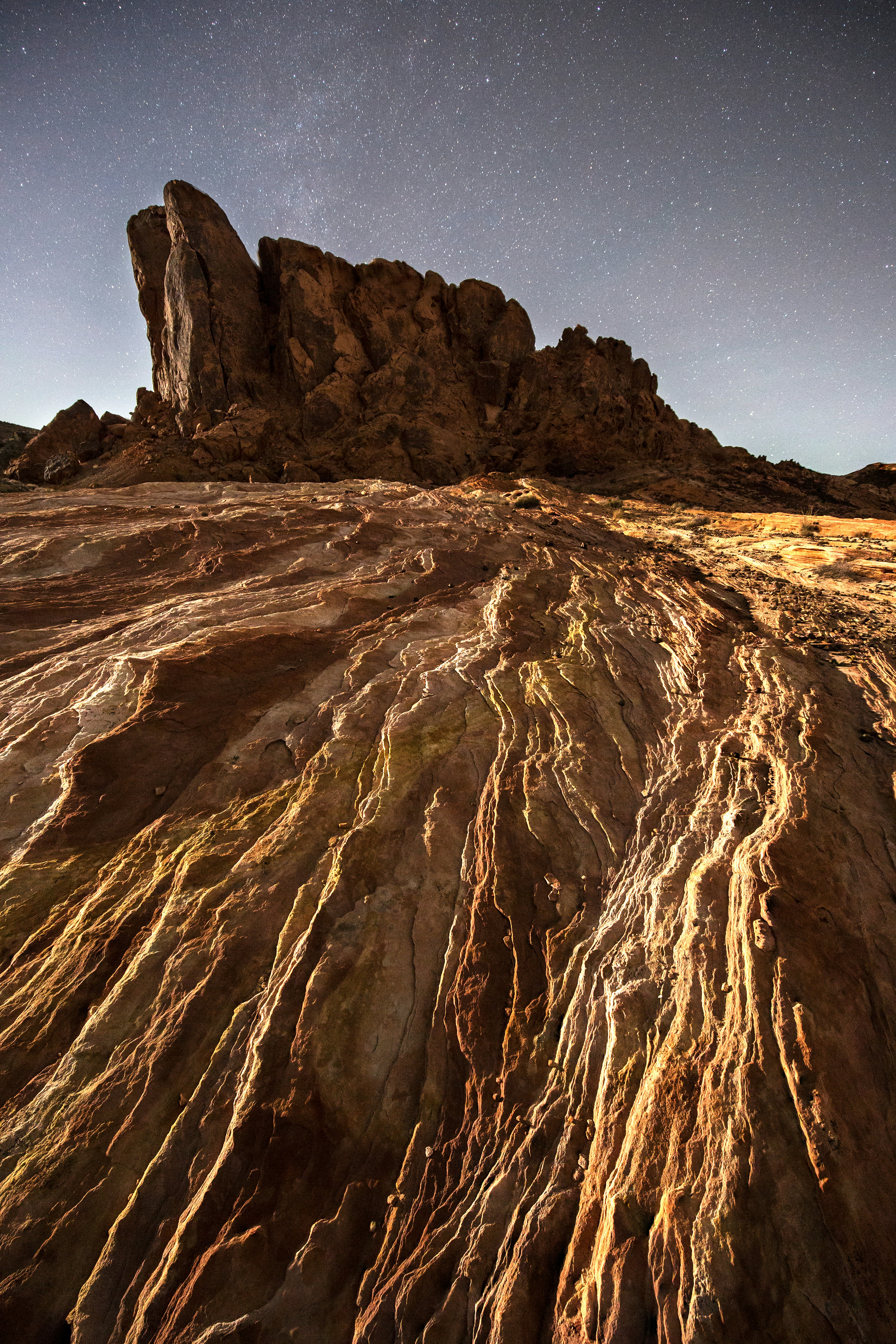 Starfall over Weathered Ridges: Night skies on jagged basalt