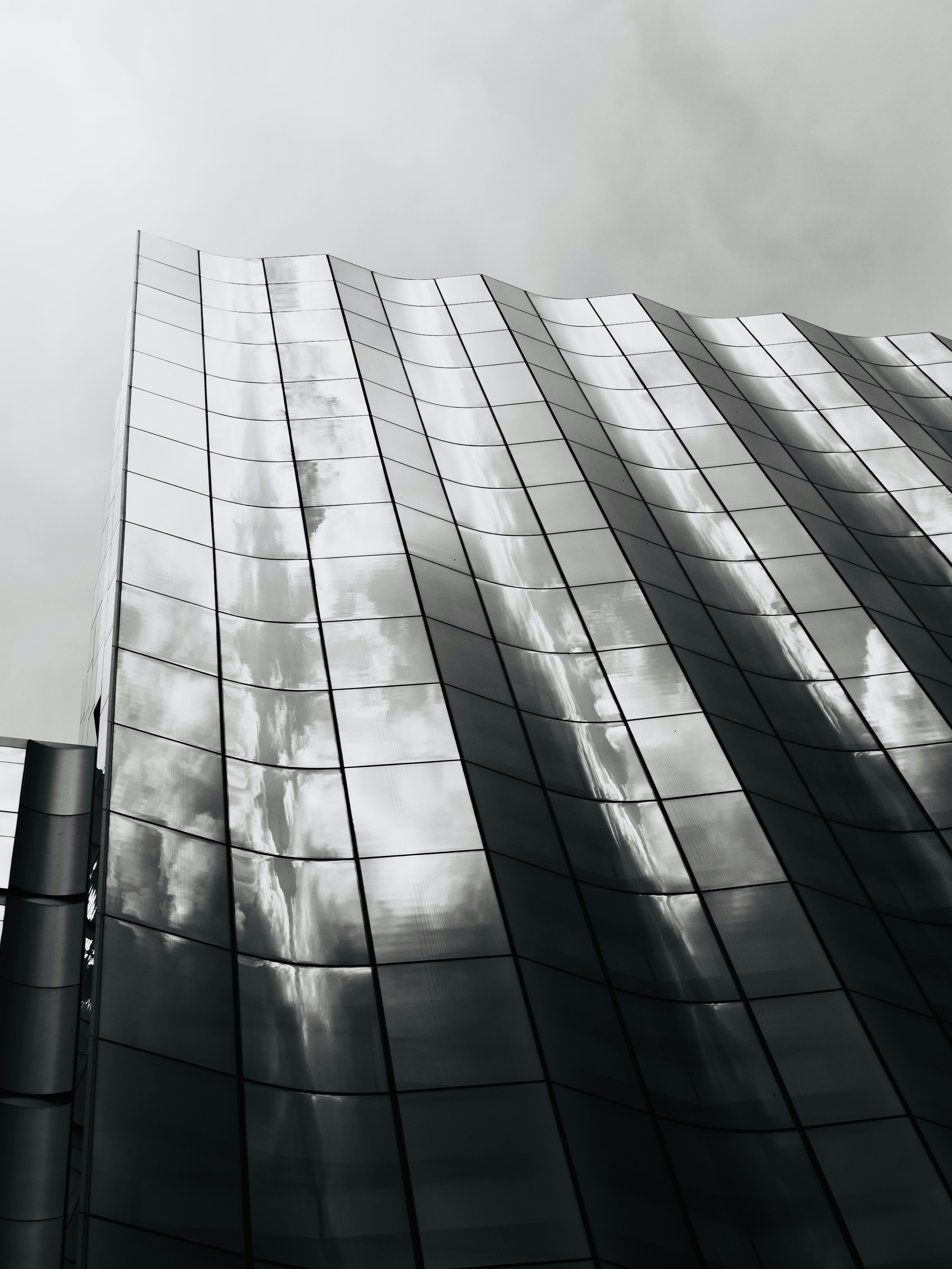 Chrome Waves: Curved Facade Reflecting Sky