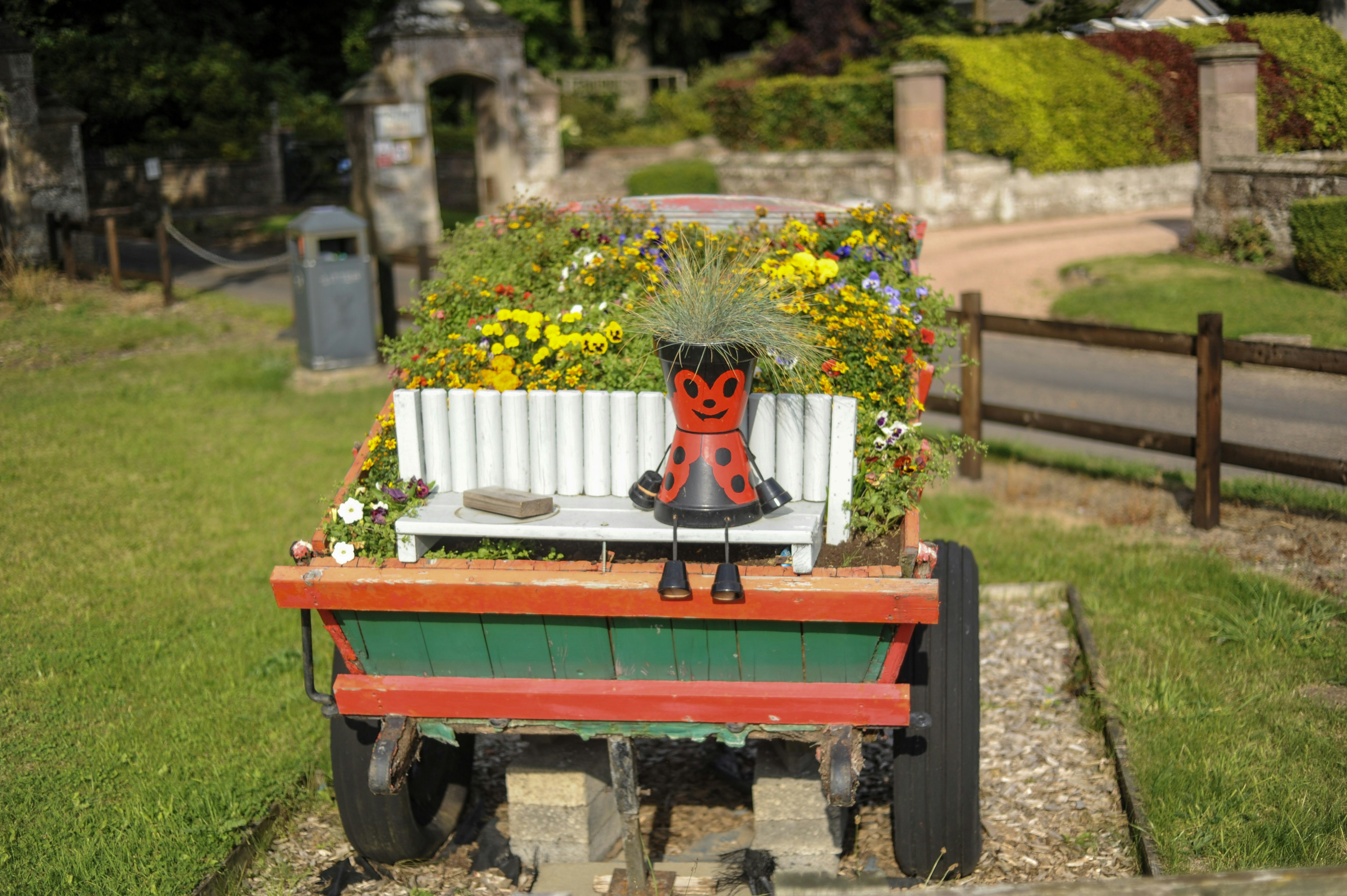 Garden Wagon with Lime Green Flowers and a Friendly Painted Figure