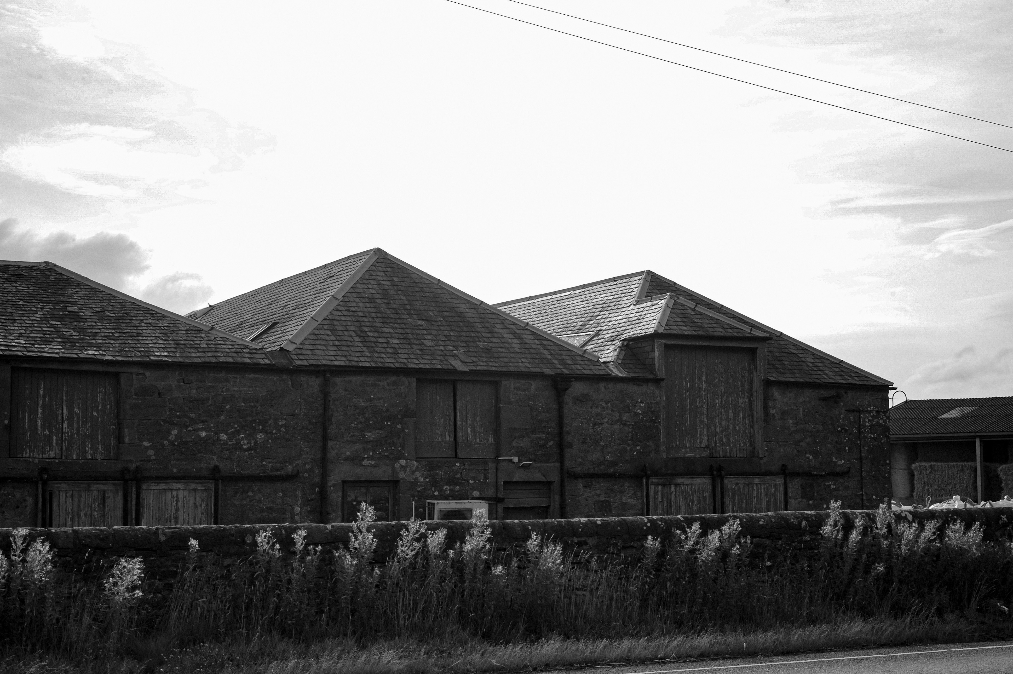 Industrial Horizon: Row of Brick Structures under a Wide Sky