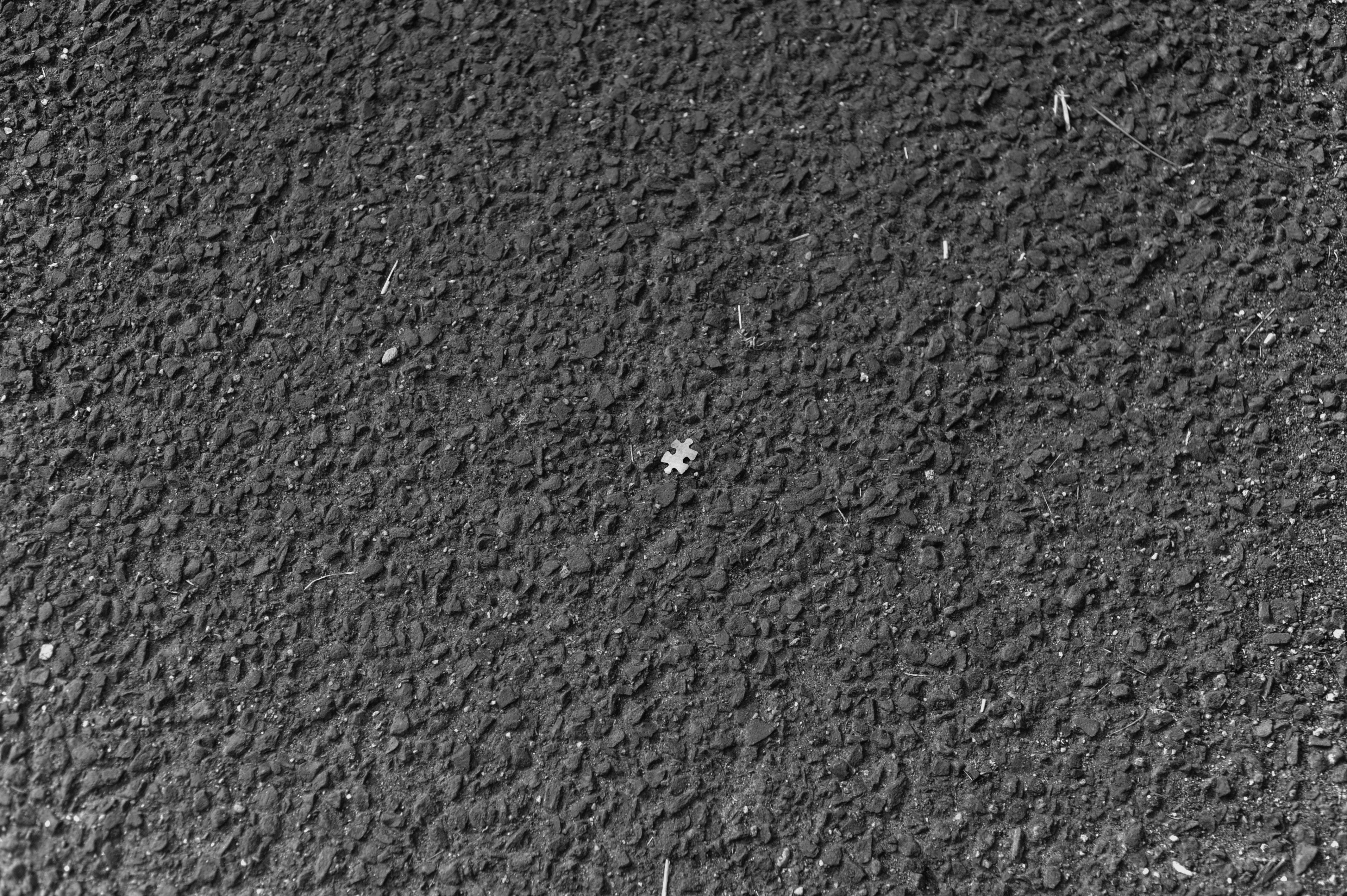 Tiny Crater in Rough Asphalt: A Micro-Detail Close-Up