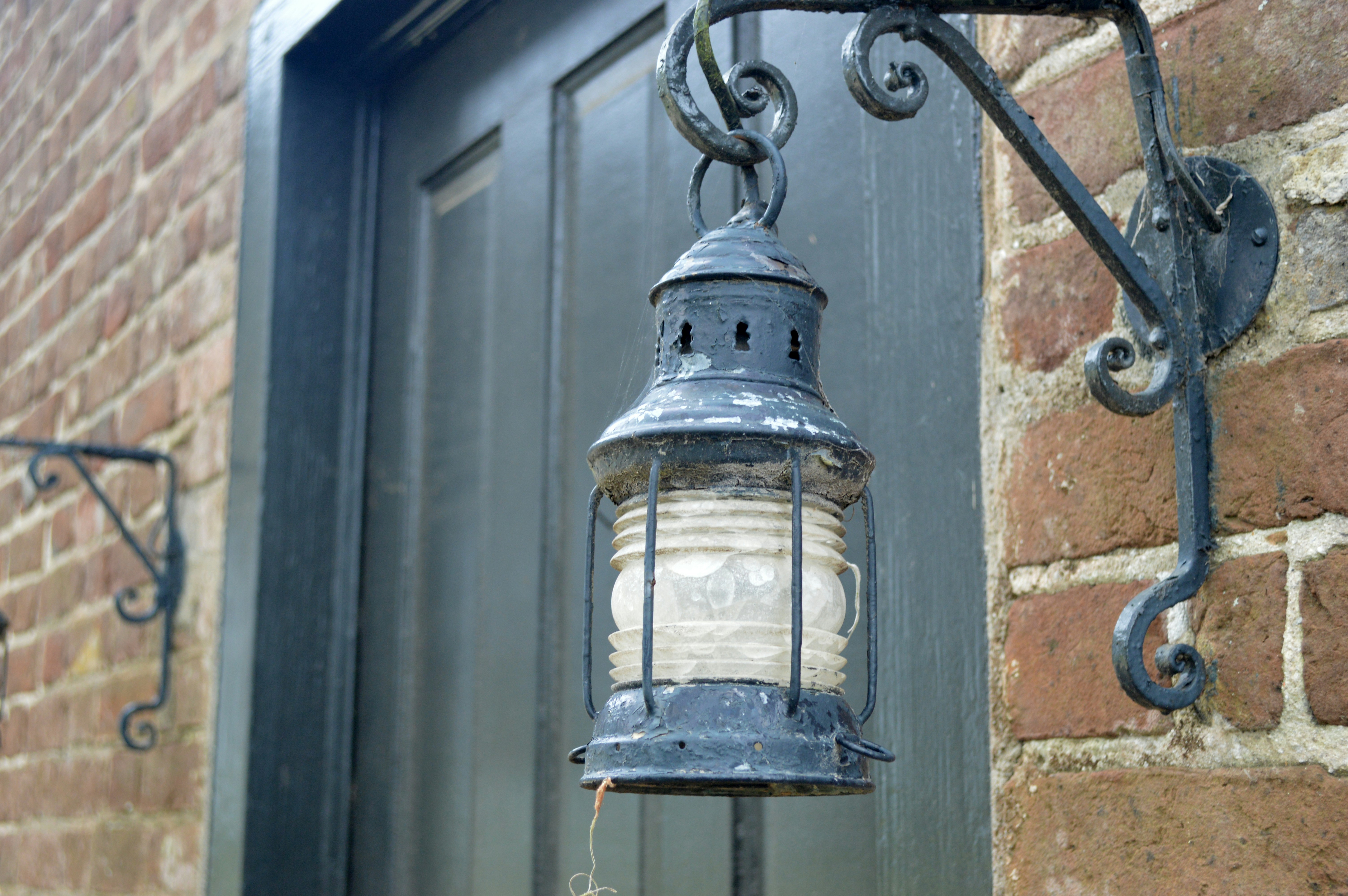 Rustic Lantern on a Brick Wall: A Quiet Industrial Charm