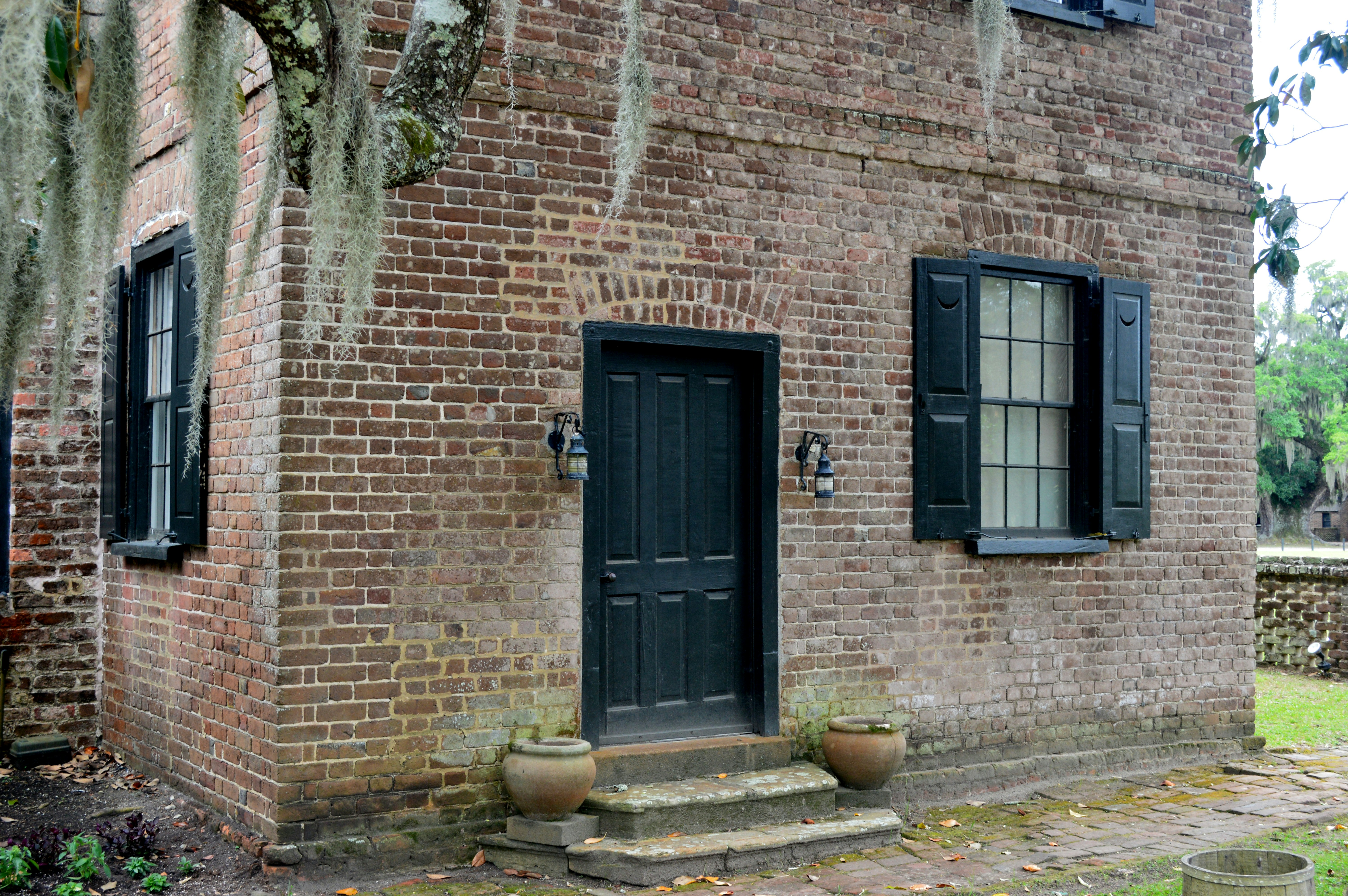 Brick Facade with Central Doorway and Verdant Courtyard