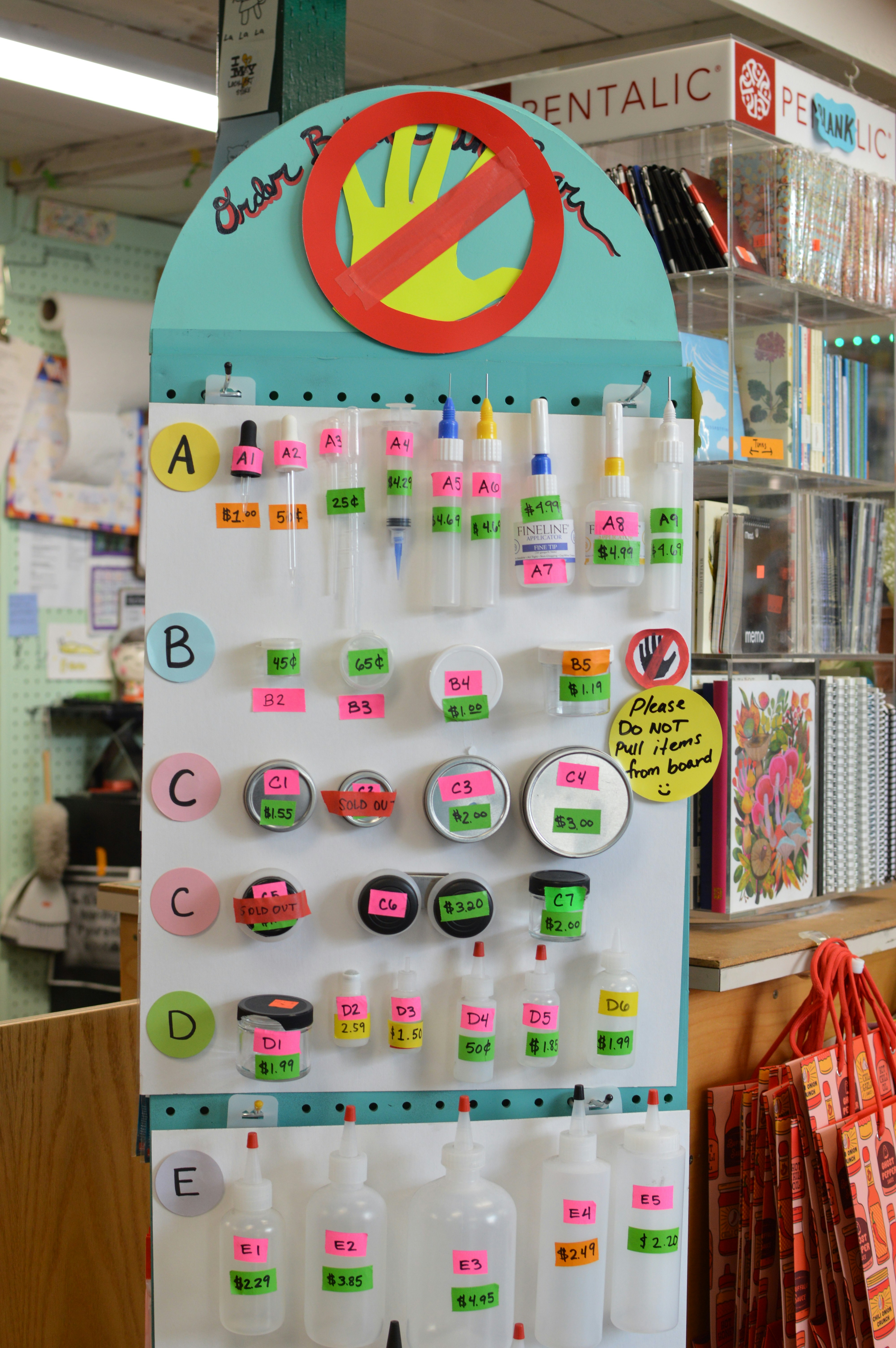 Colorful craft tool display with price-tagged silicone bottles