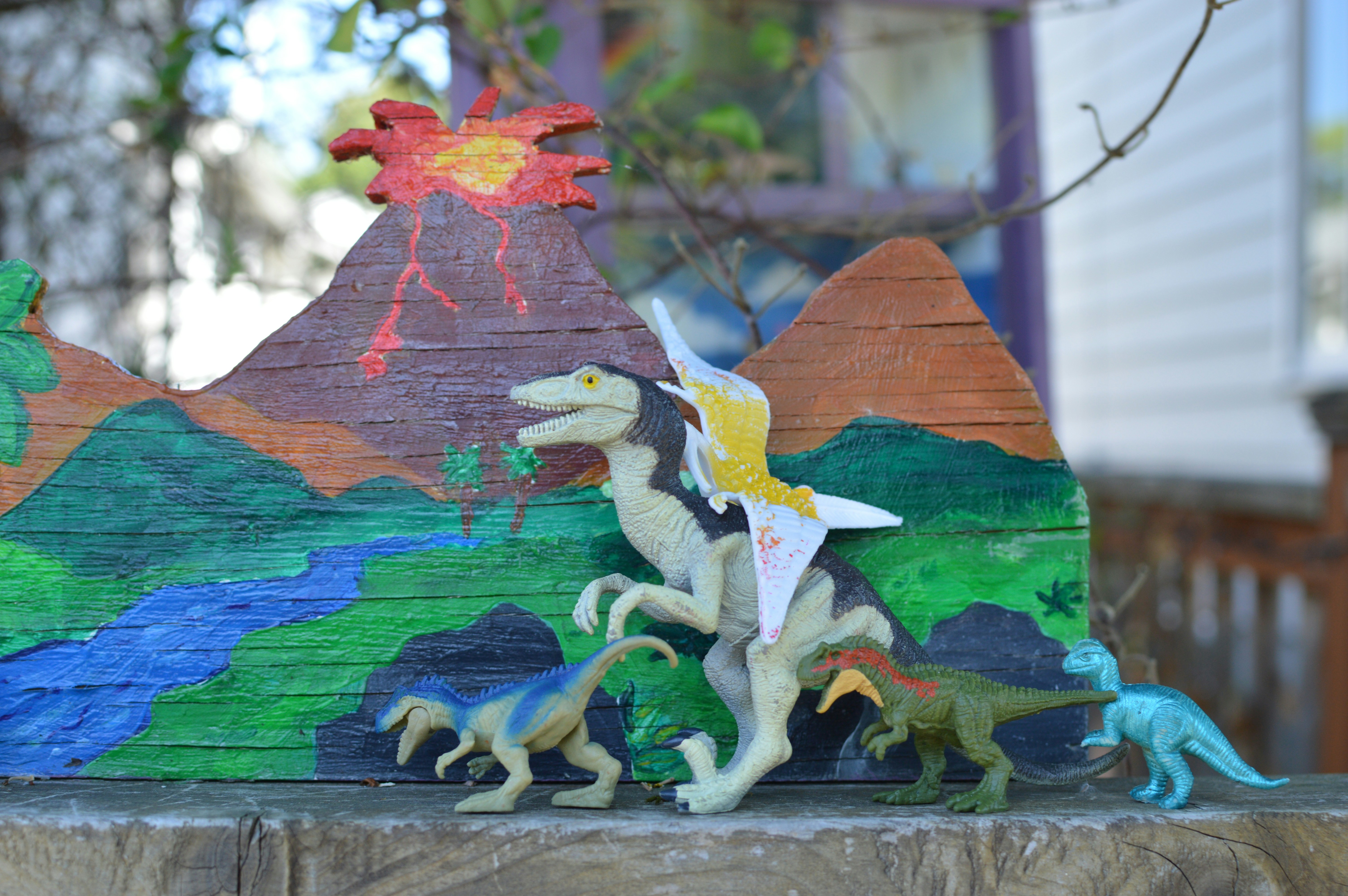 Dino Playground: Painted Wooden Crest with Dinosaurs and Sunset Mountaintops