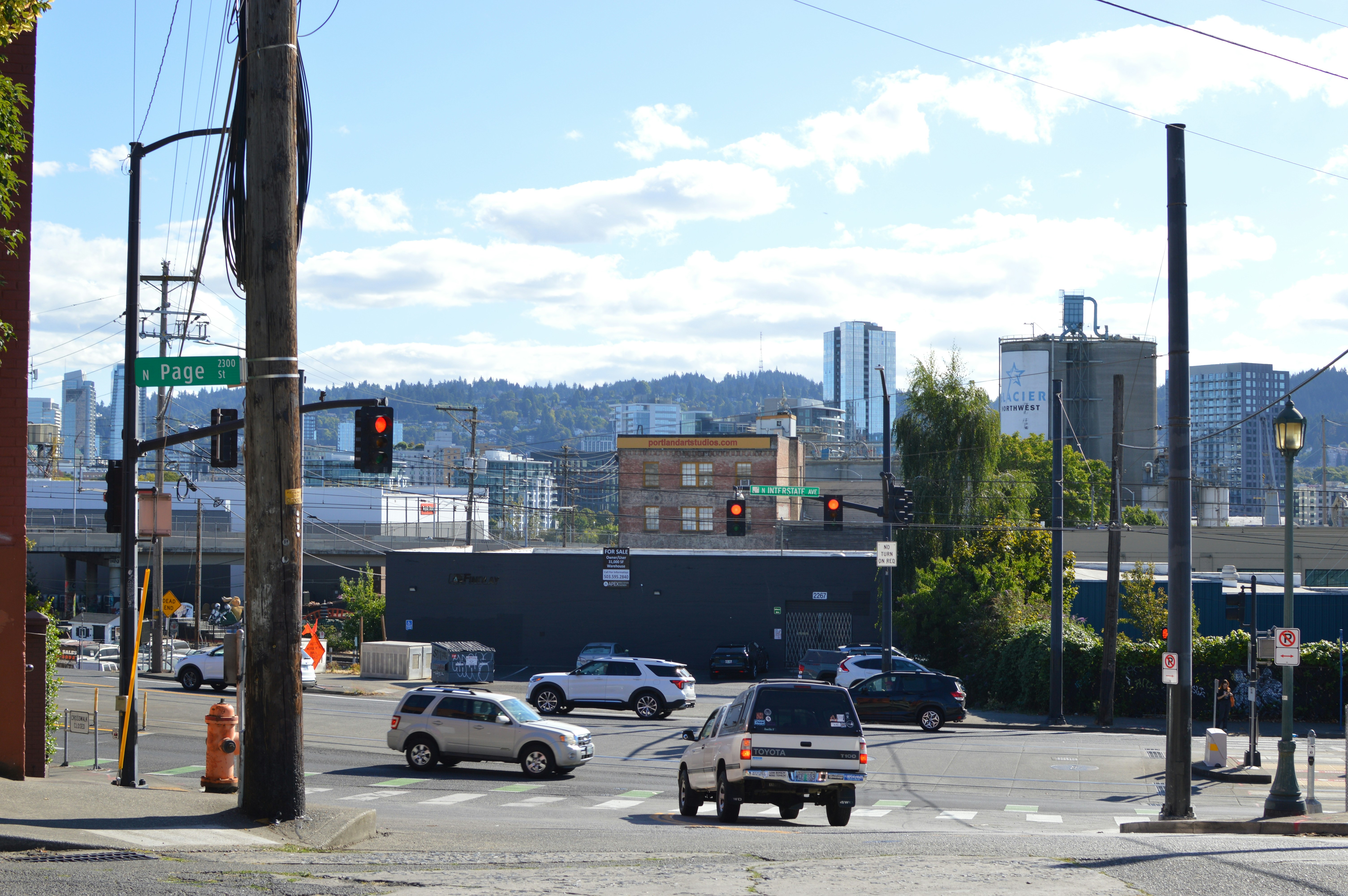 Urban Intersection at Dusk: Traffic, Signals, and Skyline
