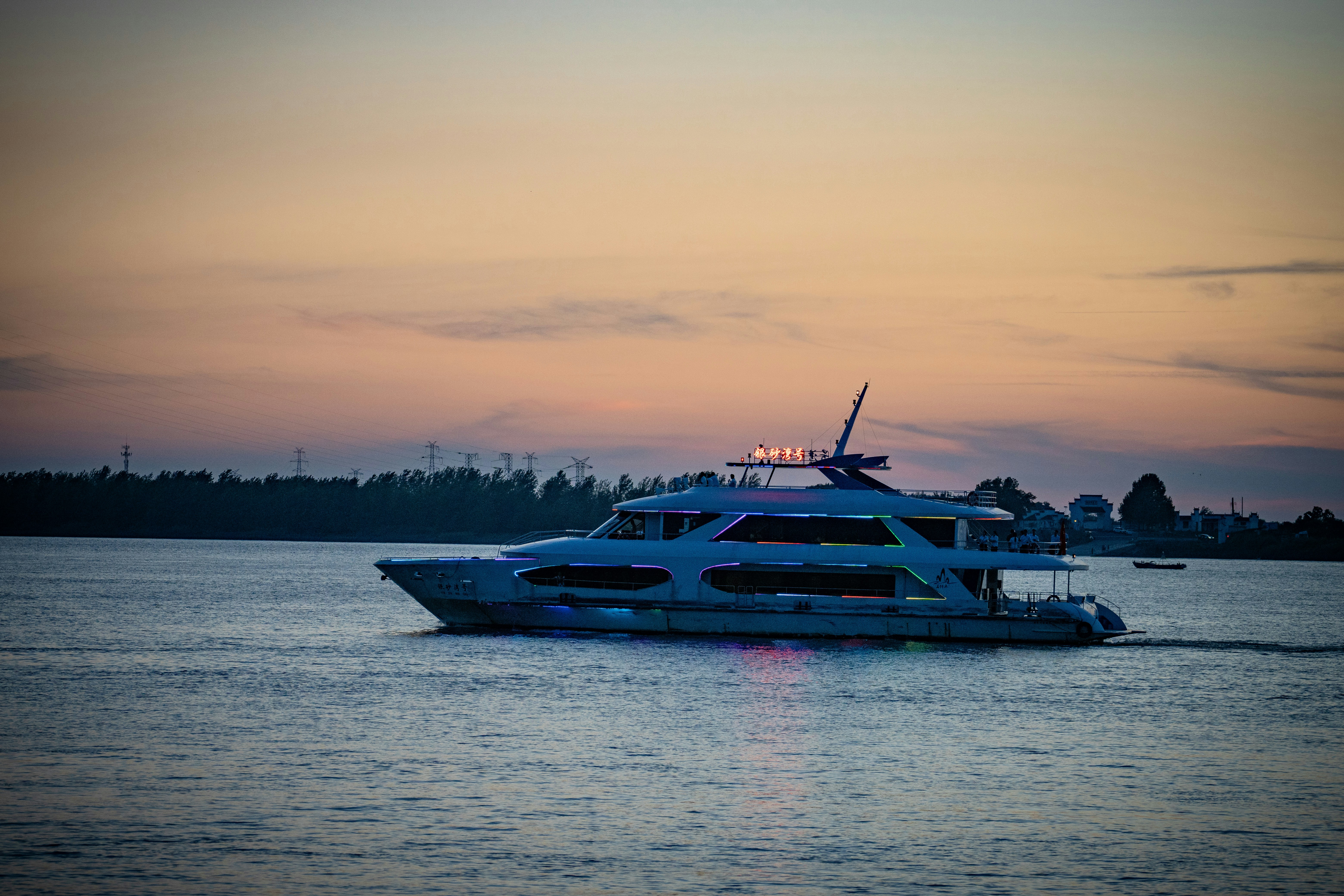 Sunset Passage: A Sloped Yacht Gliding Across Dim Water