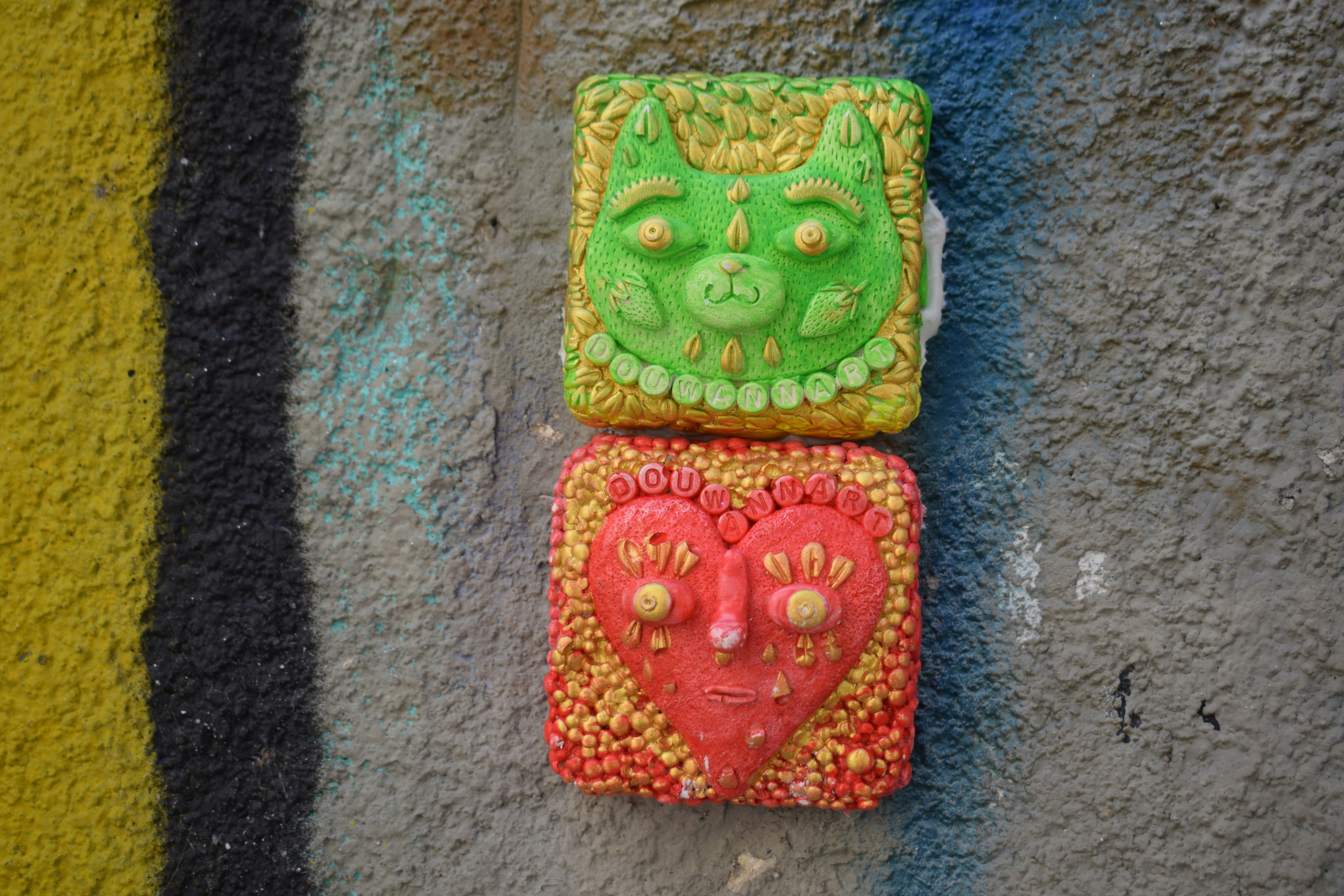 Stacked Colorful Faces in Stone: A mural of cheerful blocks