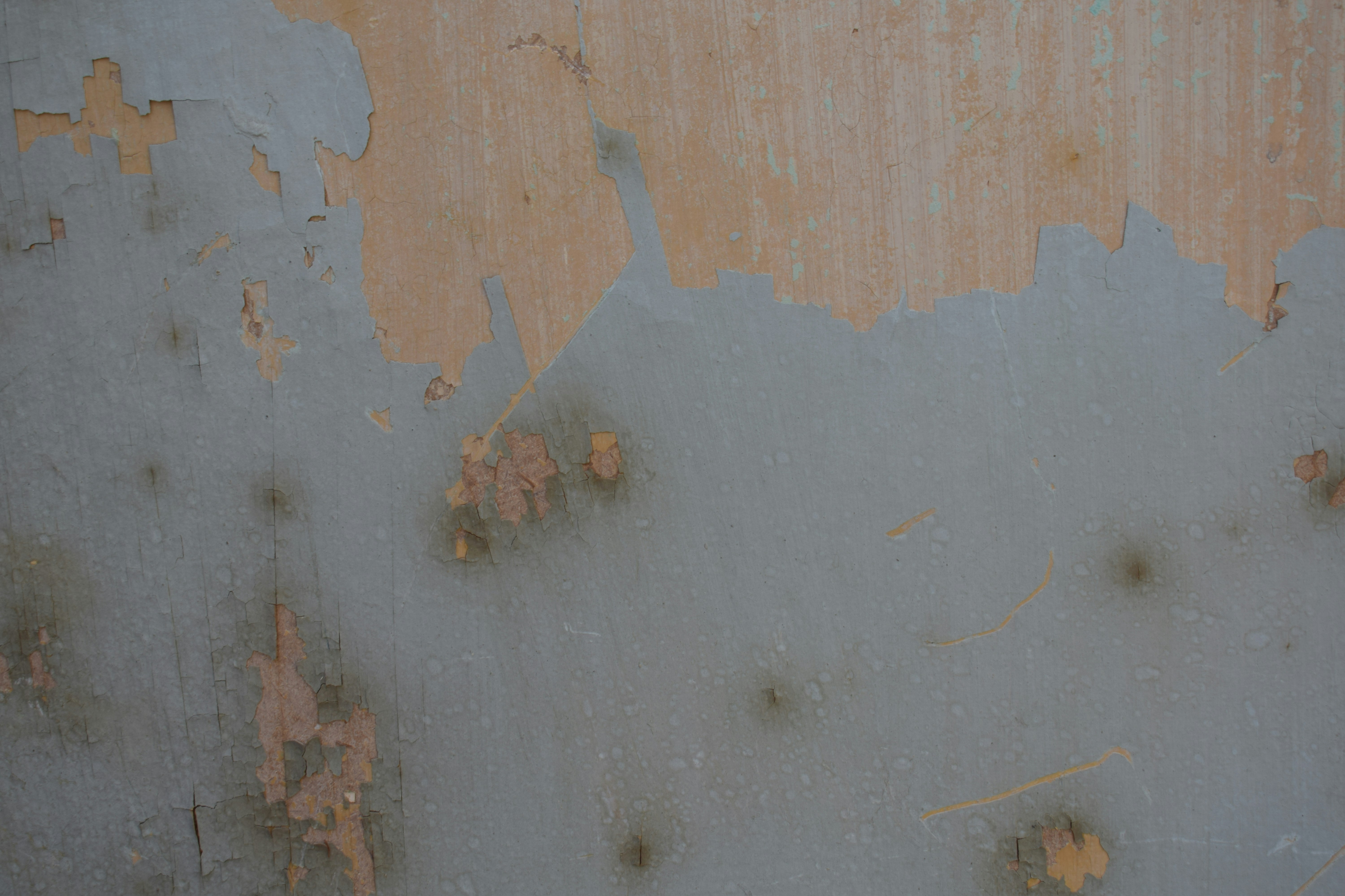 Peeling Paint and Patina on a Weathered Wall