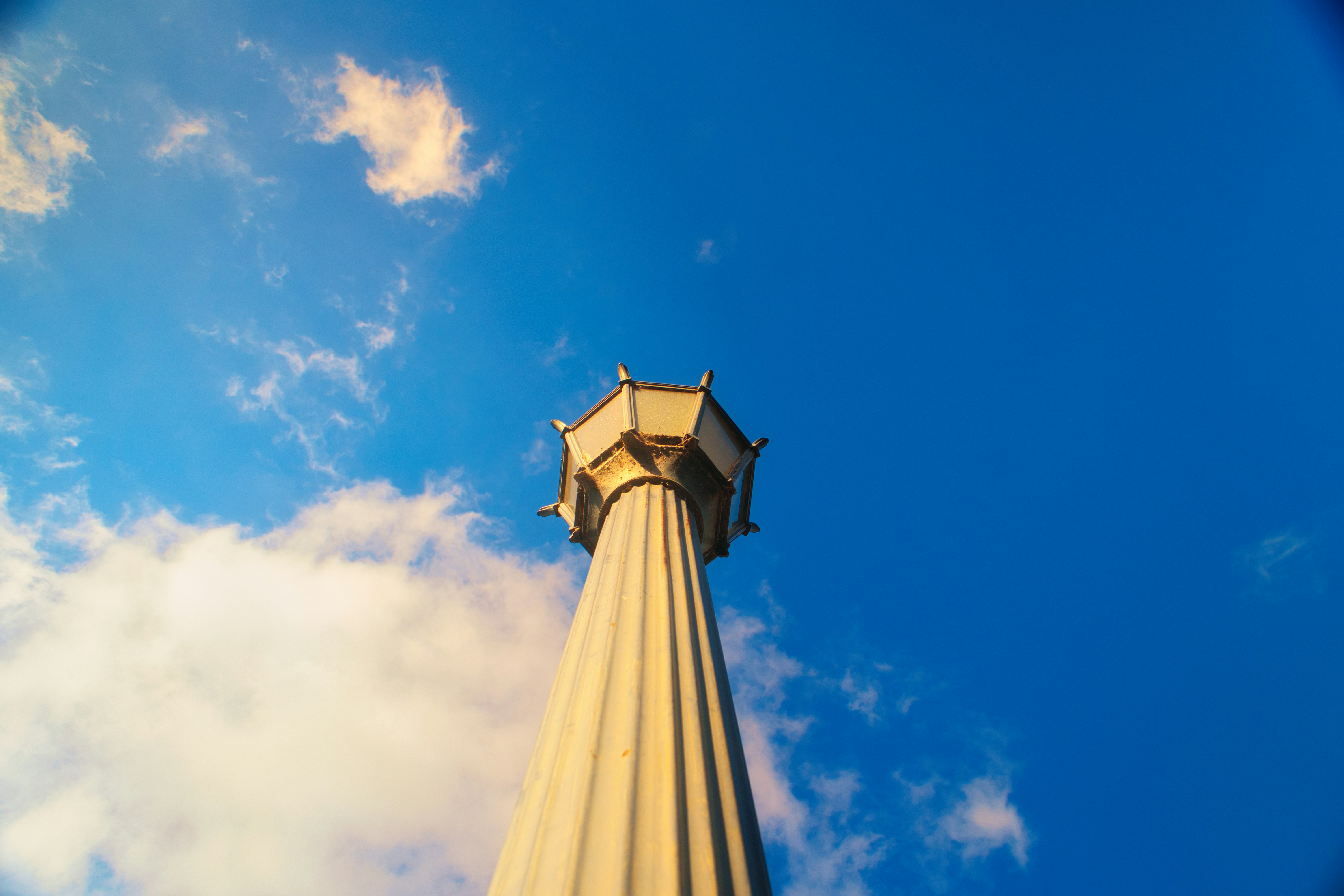 Uplifted Beacon: A Sky-Worn Tower Reaching for Daylight