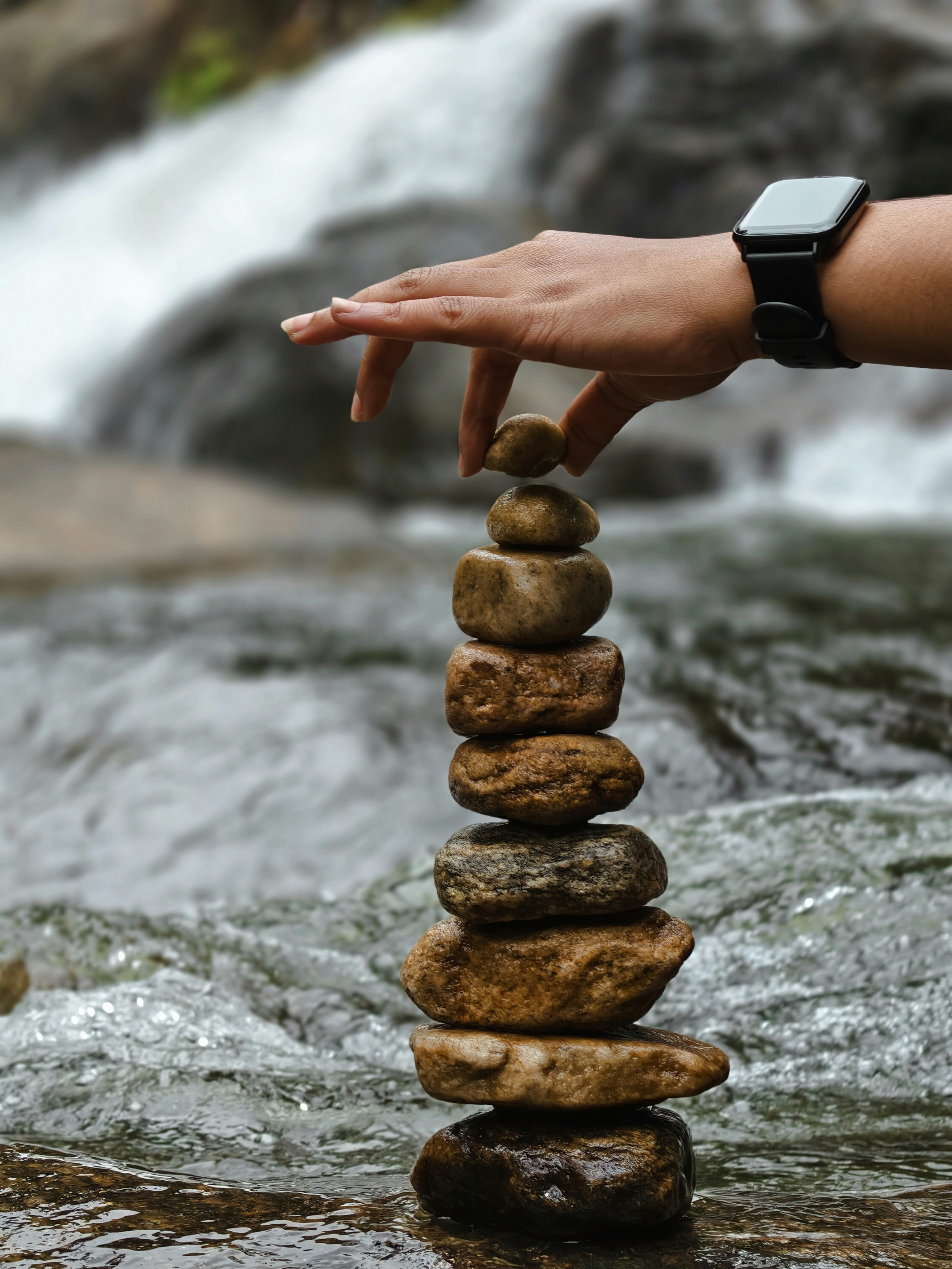 Balanced Cascade: Stones under a Hovering Hand by the River
