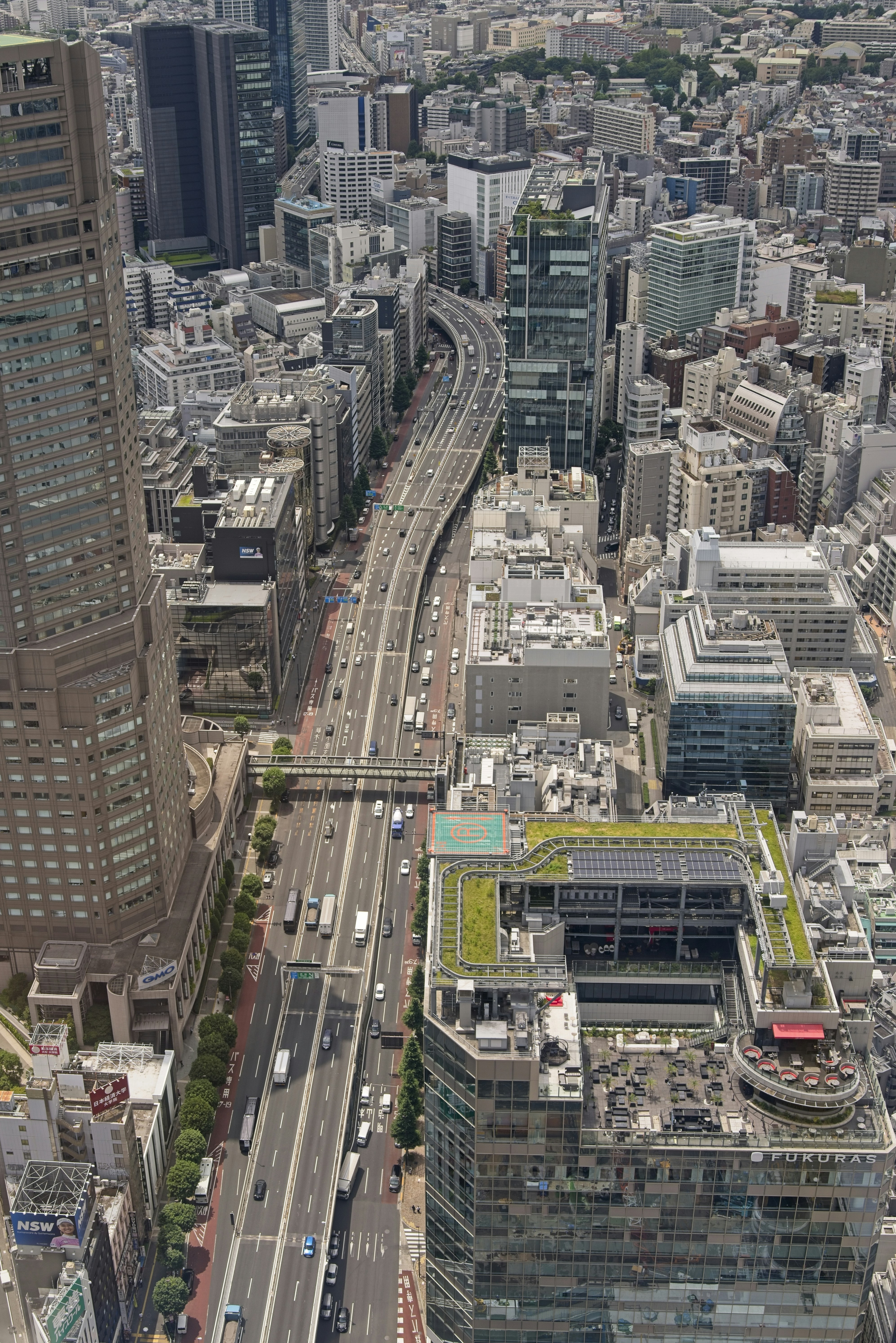 Aerial Cascade: The Artery Carving Through a Concrete Spine