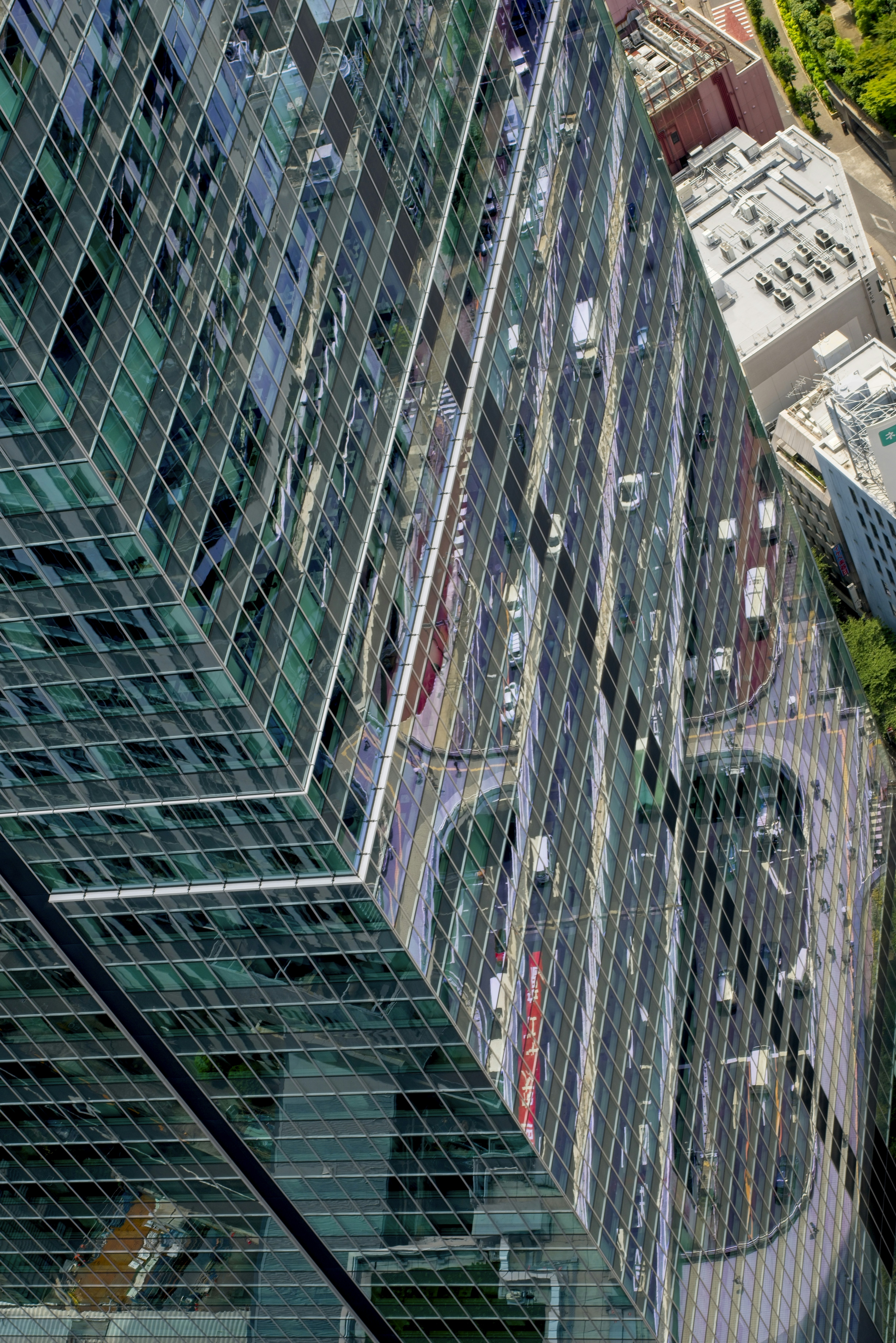Tilted Glass Facade: Aerial Cascade of City Reflections