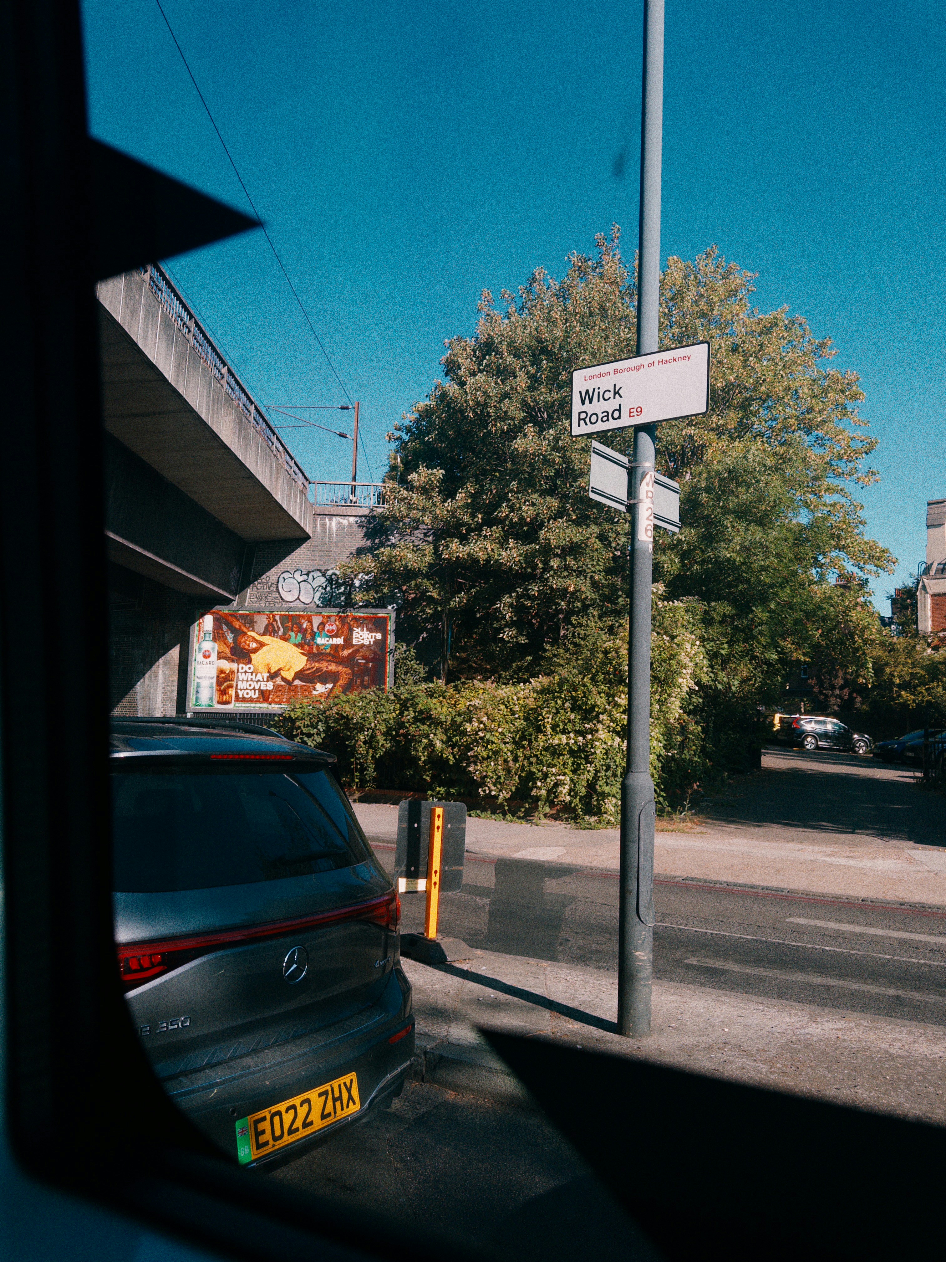 Street Corner in Bright Daylight with Vehicle and Signpost