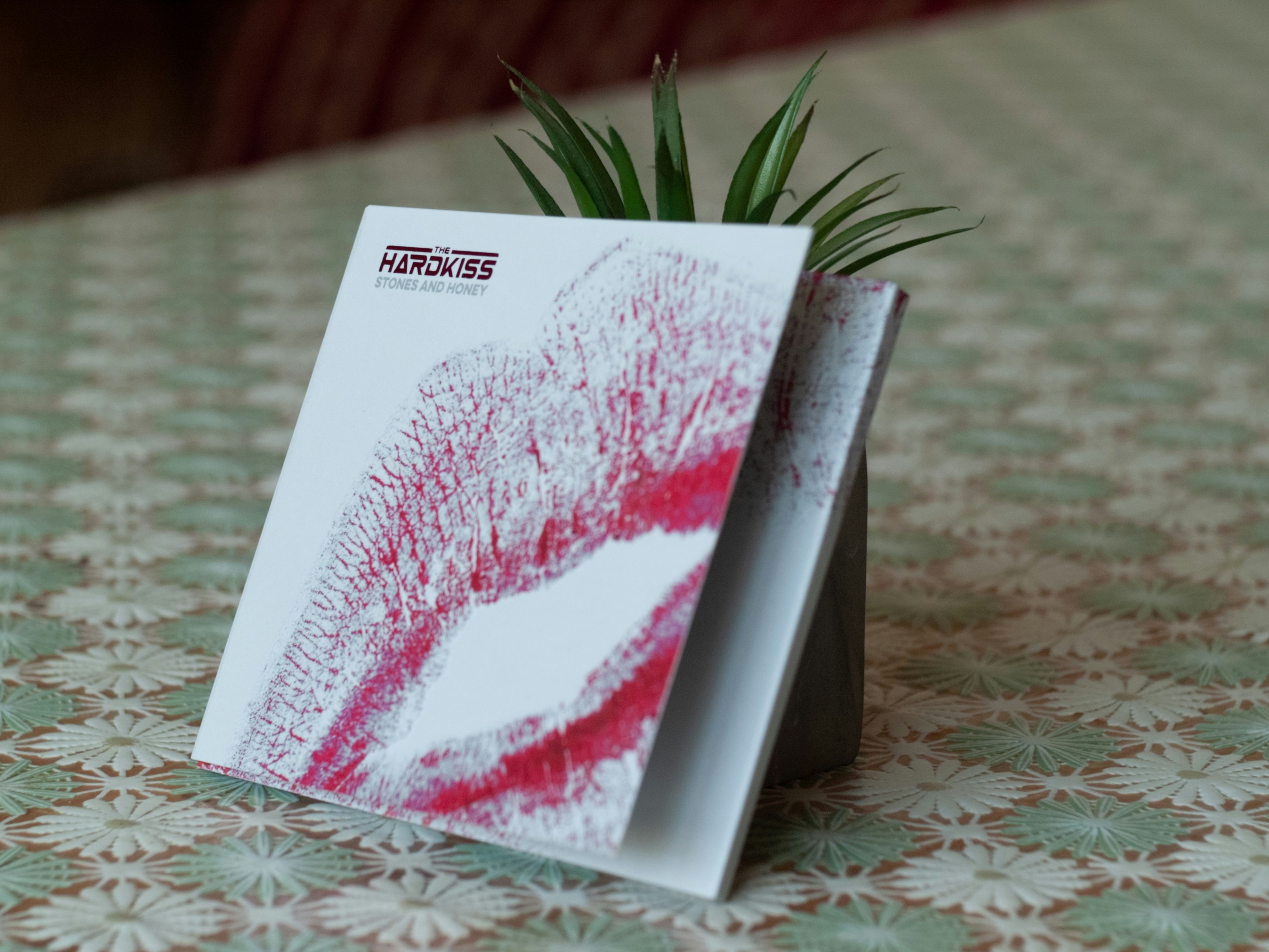 Kiss Card: A Folded Portrait of Red Lip Imprint on a Tabletop Card