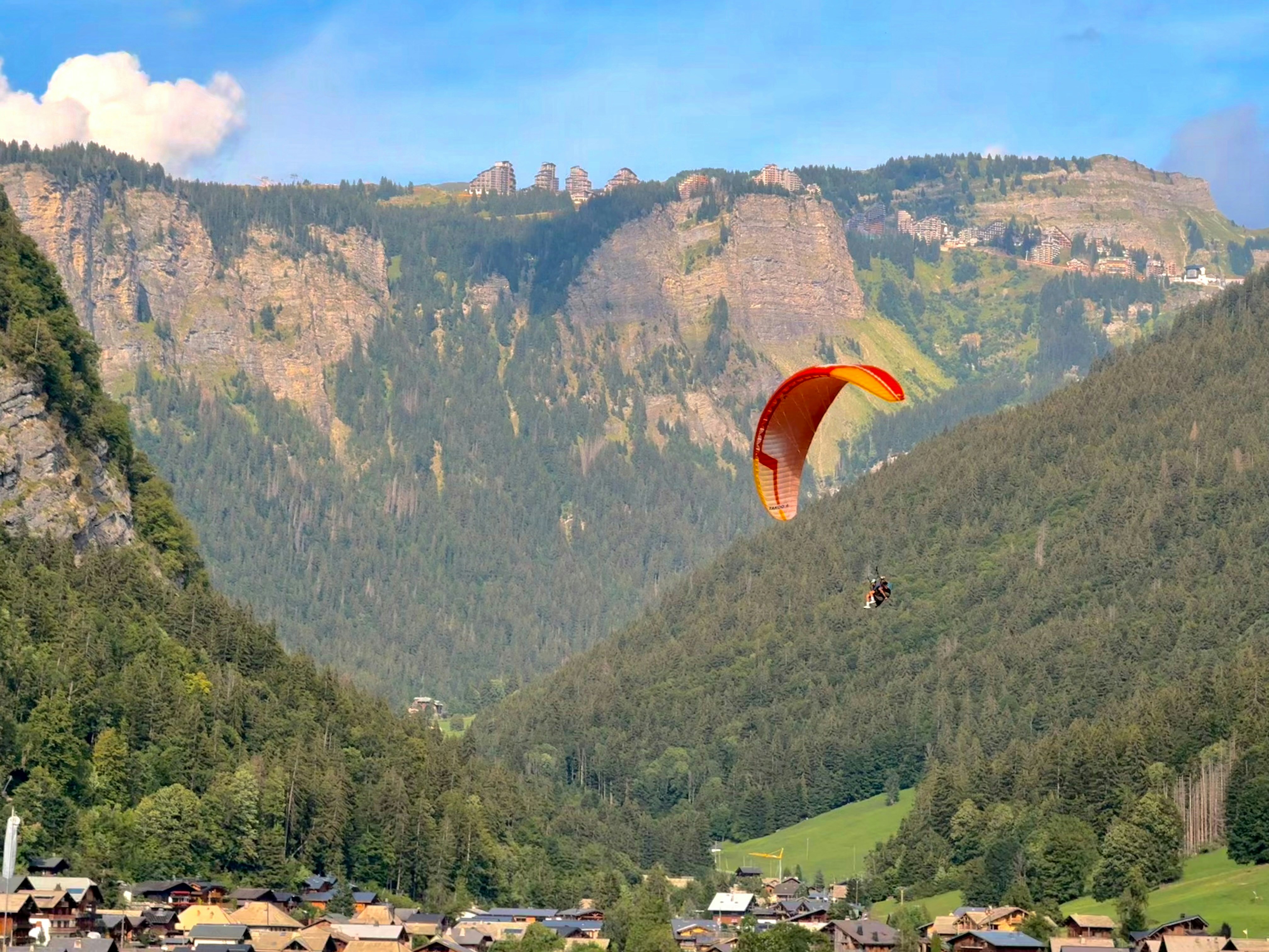 Kite on the Mountain Ridge above a Alpine Village