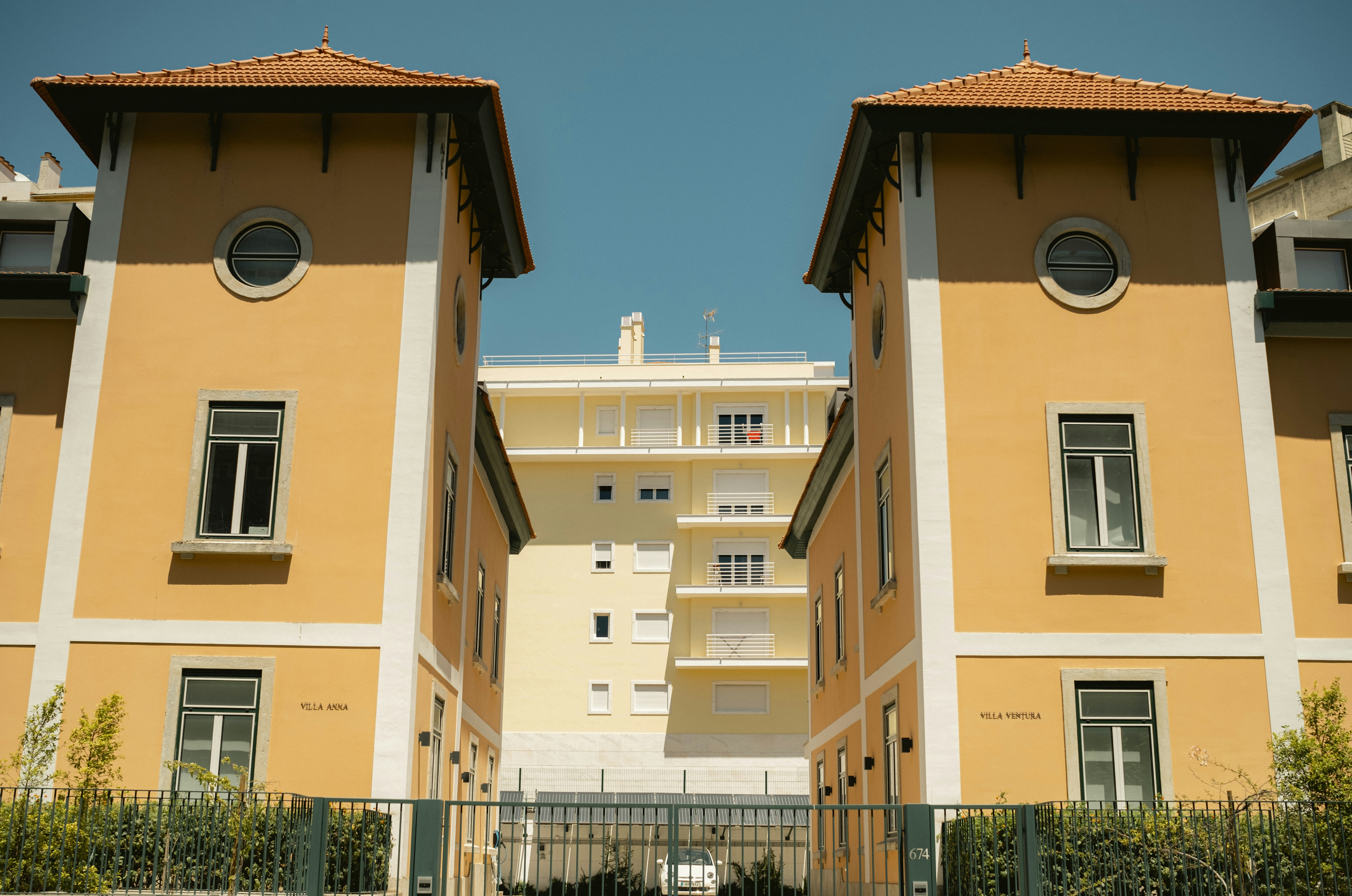 Symmetric Courtyard Towers: Golden Facades Framing a Central Passage