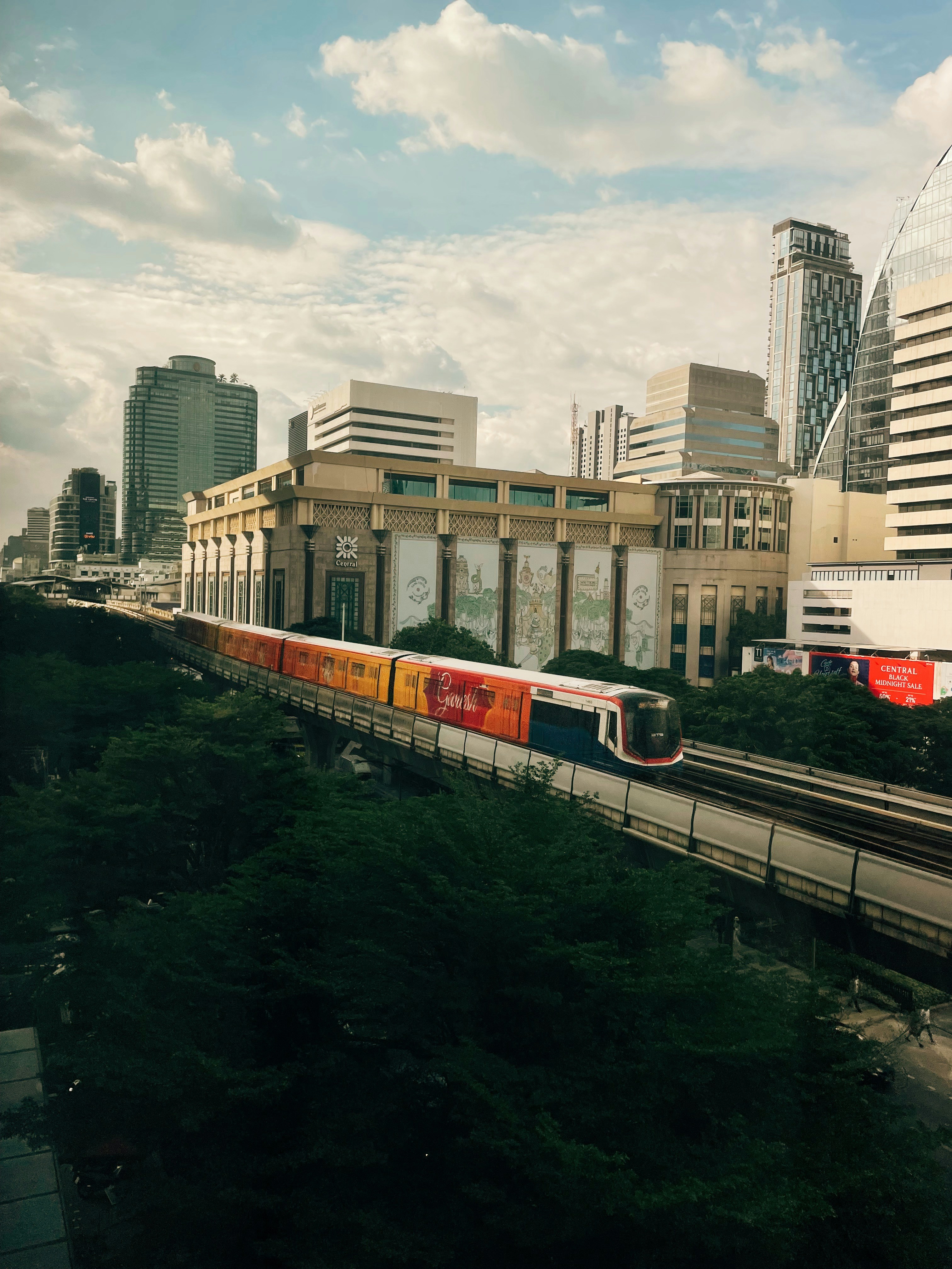 City Rail in Motion: Modern Architecture Framed by a Red-White Train
