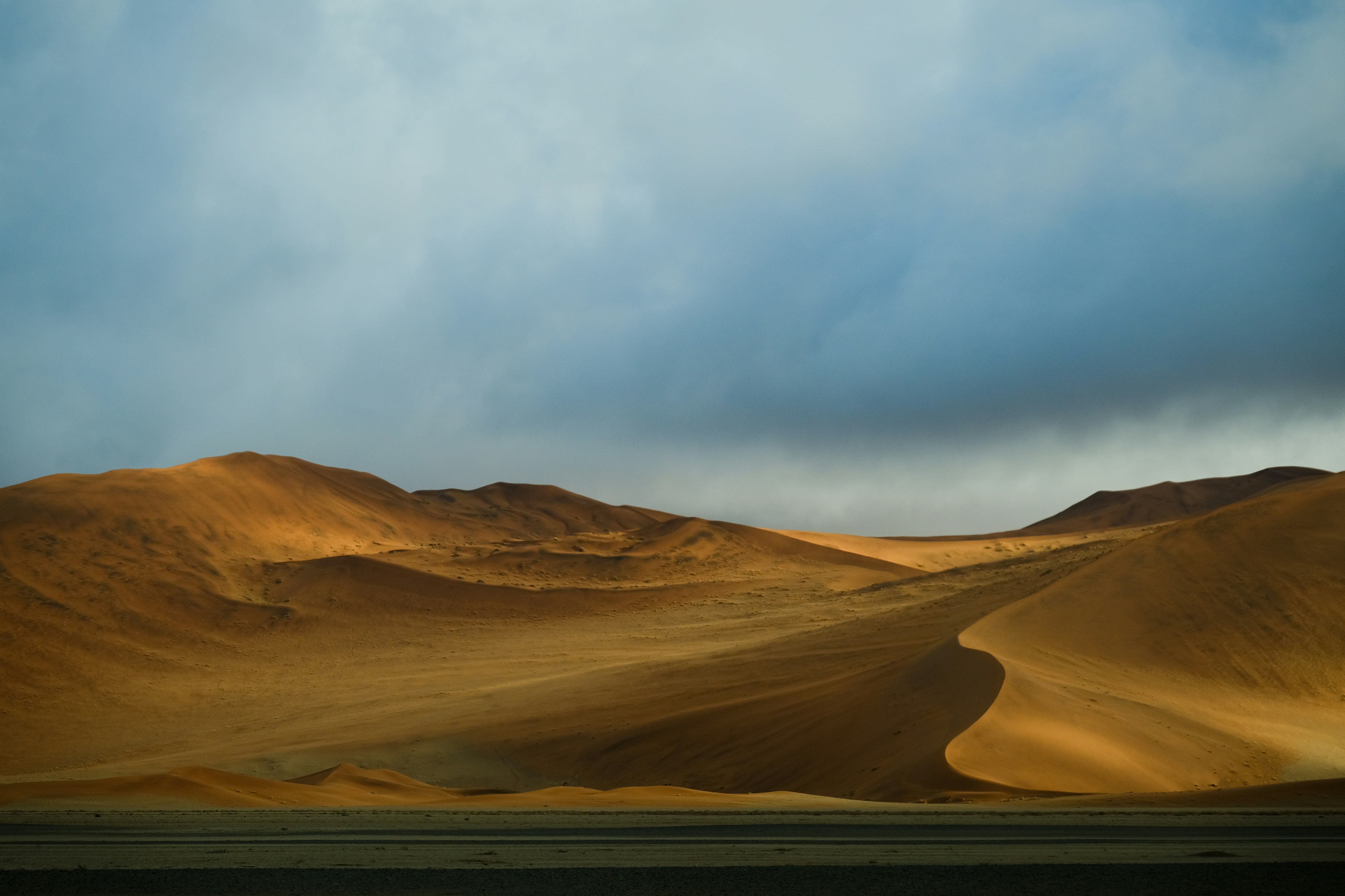 Dune Ridge Under a Tempest Sky