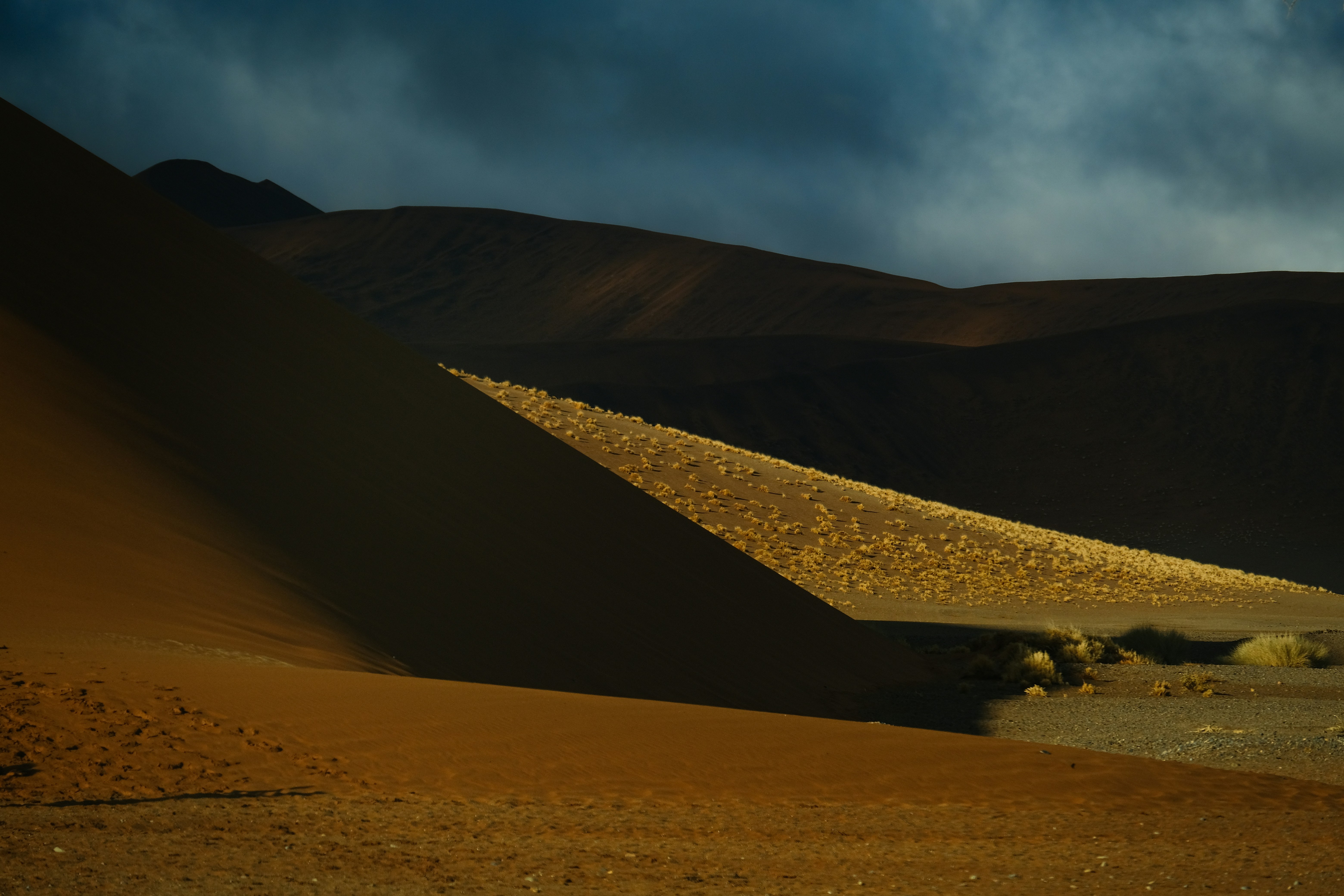 Golden Ridge: A Moonlit Dune Under Coastal Clouds