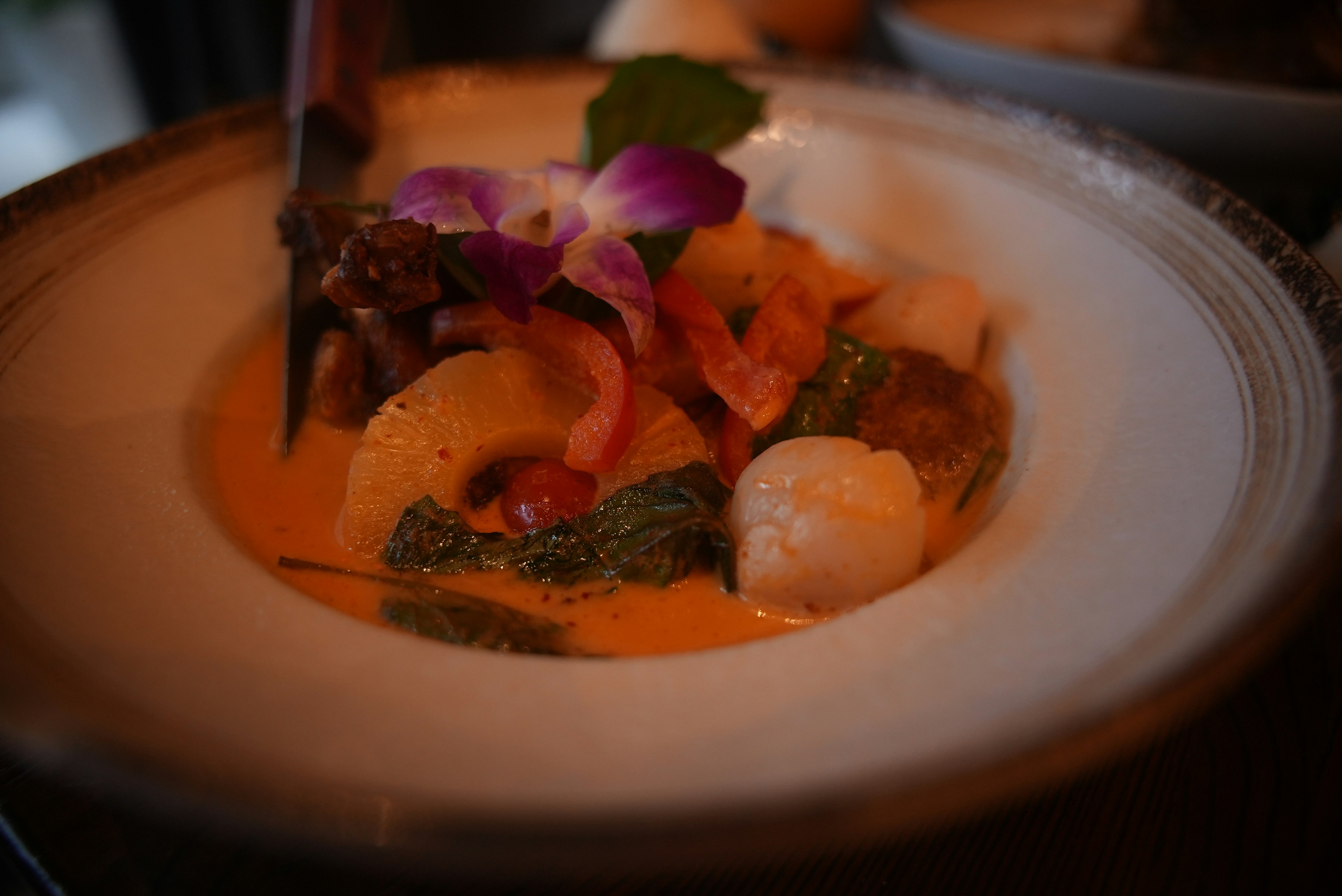 Orchid Garnish and Citrus-Saffron Broth: A Moment in a Deep Plate