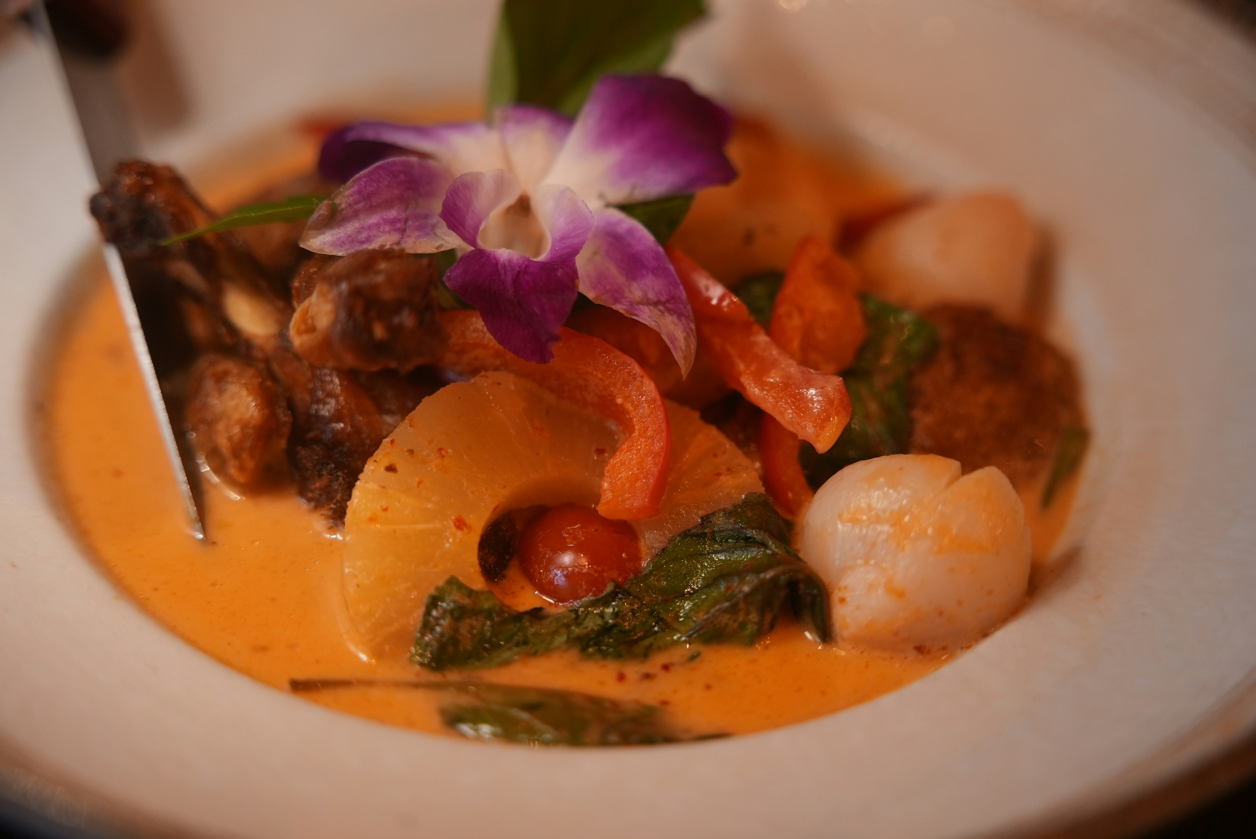 Citrus-Cilled Seafood in Creamy Orange Broth with Edible Orchid