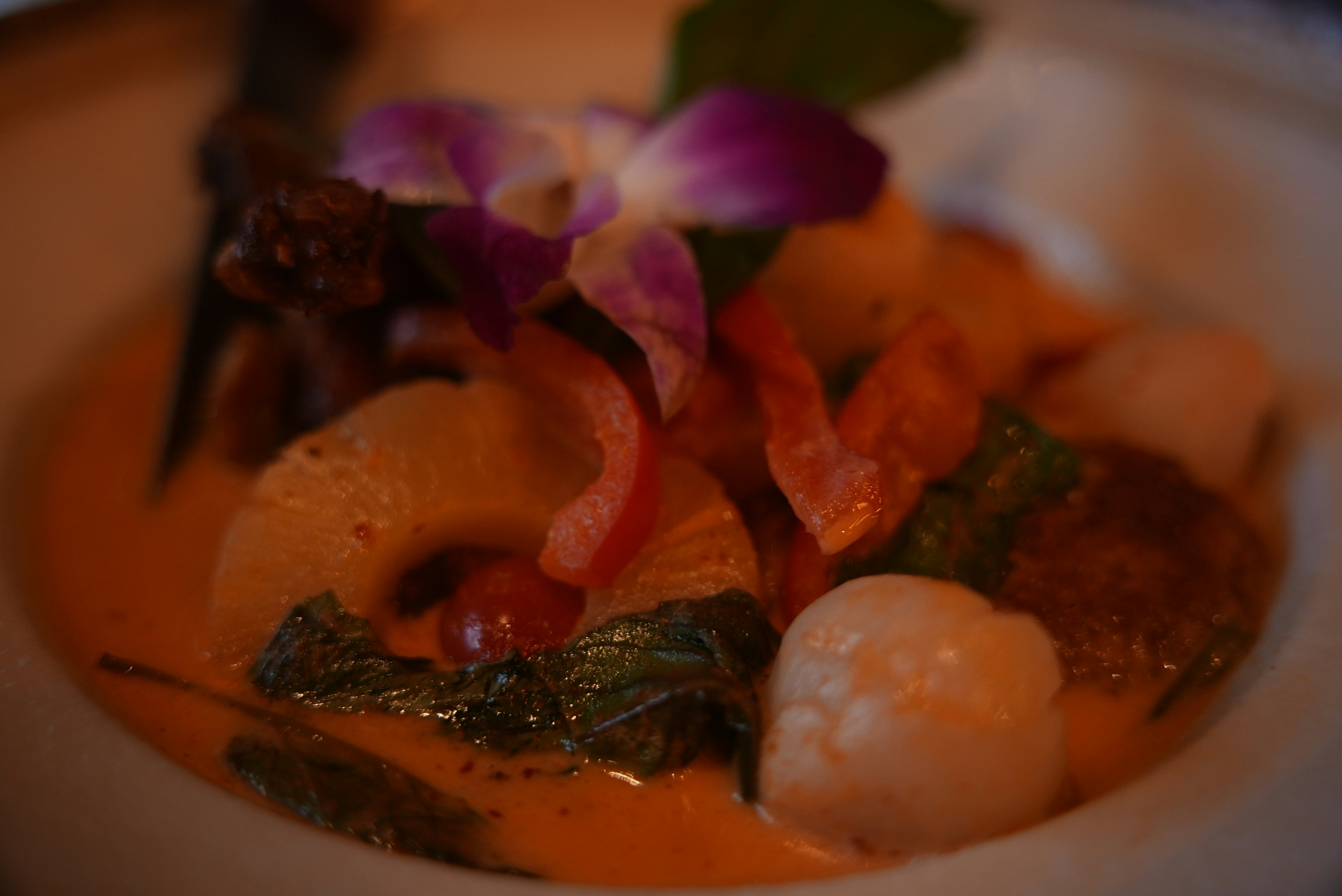 Orange-Saffron Seafood Medley with Edible Orchid Garnish