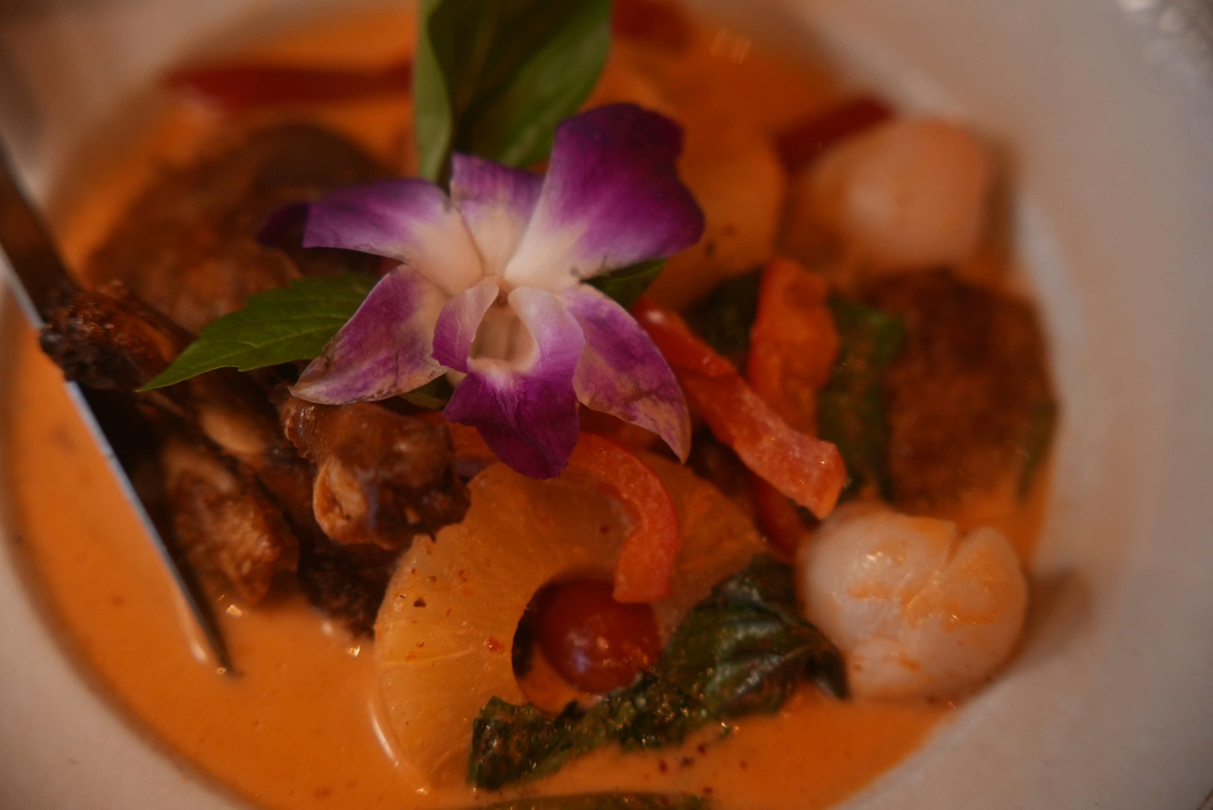 Orchid Garnish over Creamy Calabrian Seafood Medley