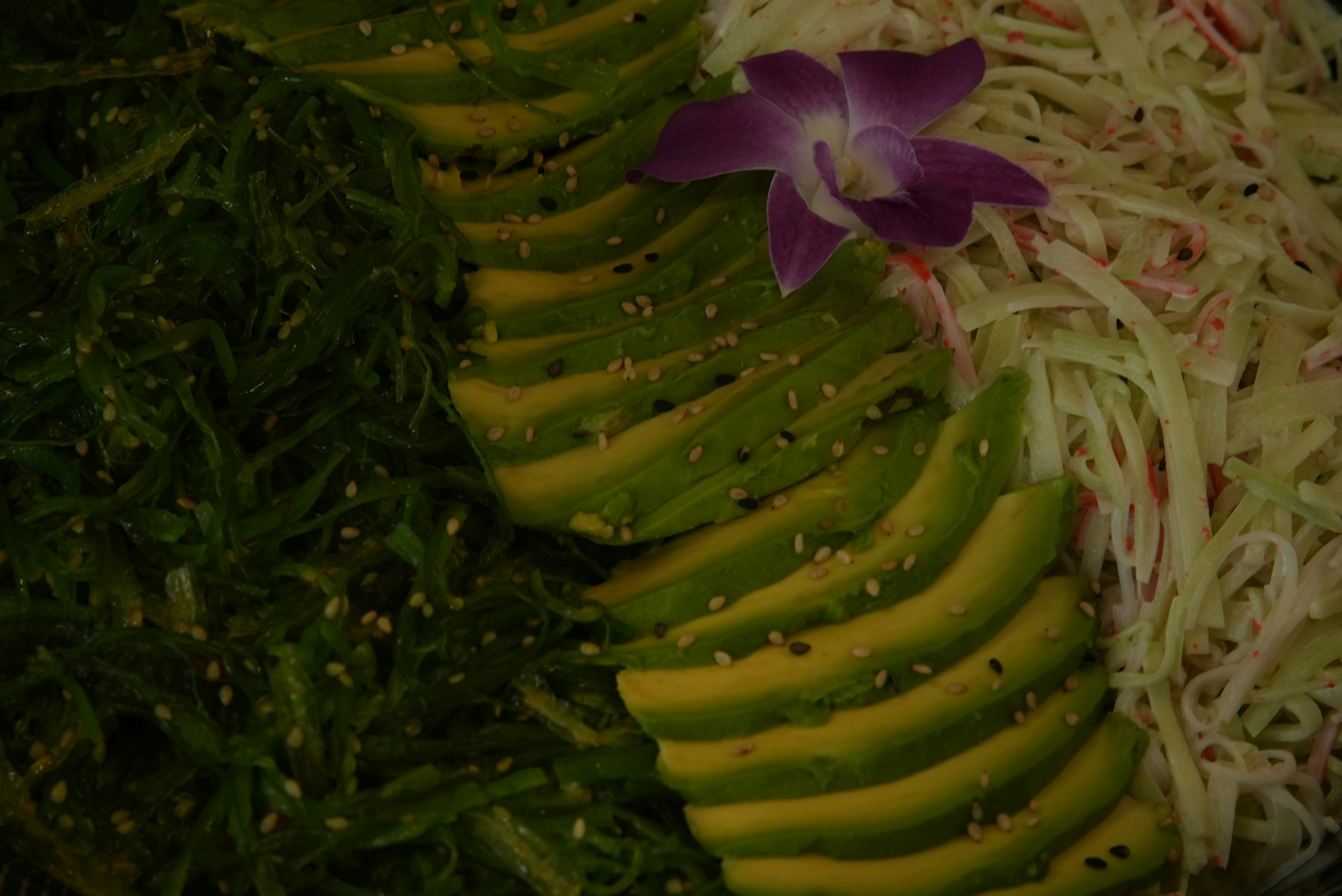 Orchid Accent Amid Curved Greenery: A Banana-Leaf Border