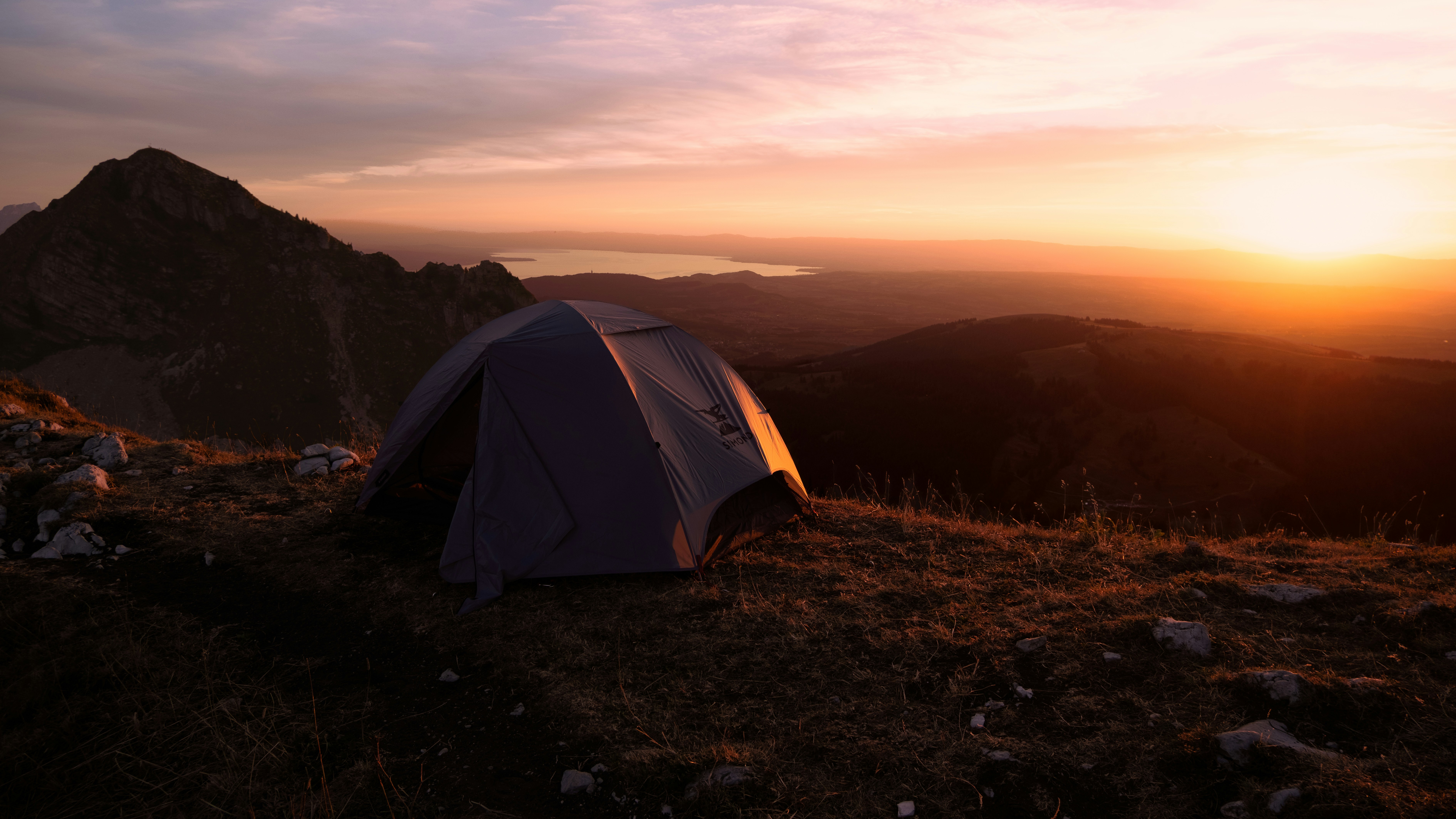 Sunset Over the Crest: A Lonely Tent on a Mountain Ridge