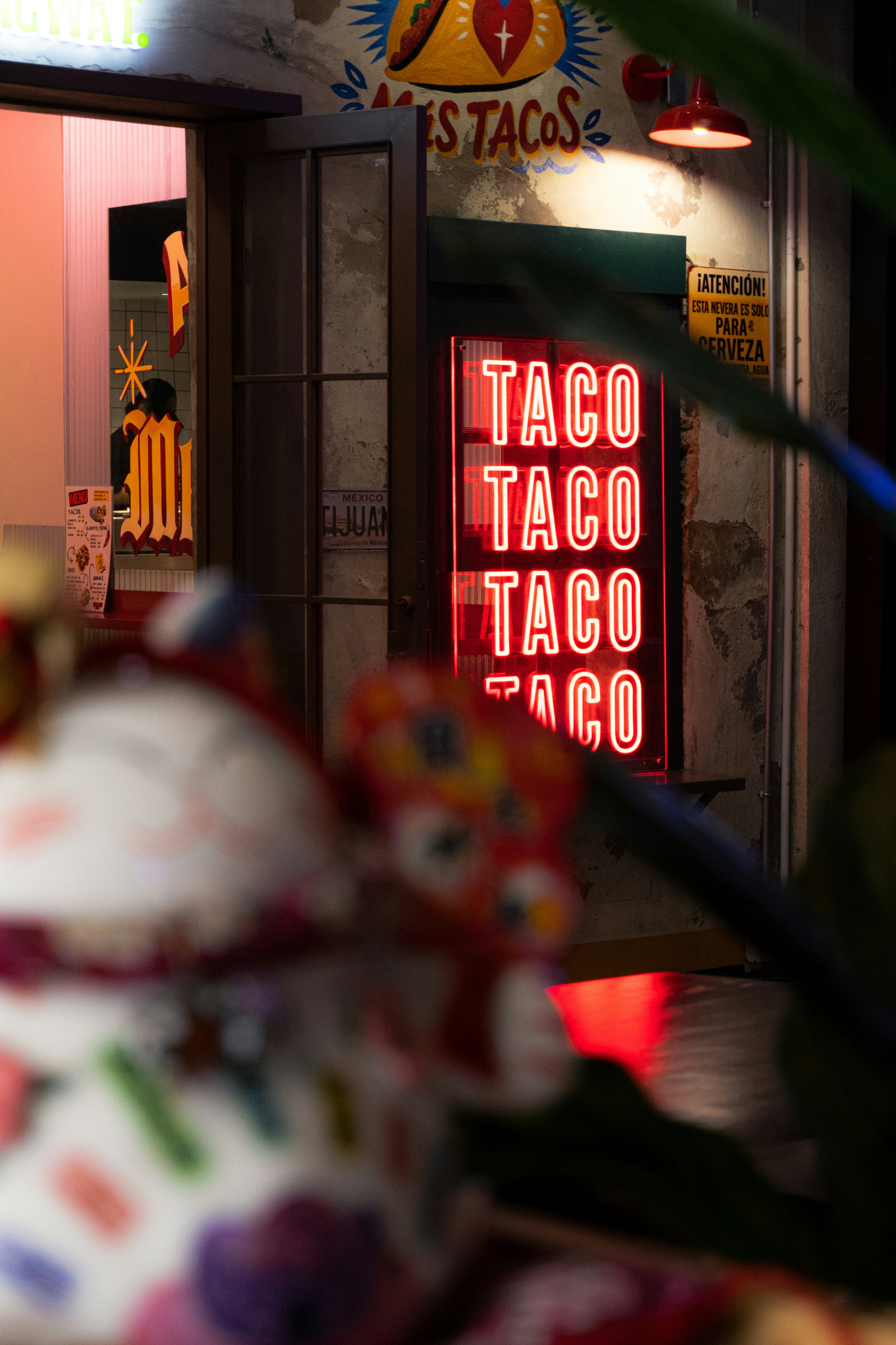 Neon Taco Night: A Bright Sign Through a Dim Entryway