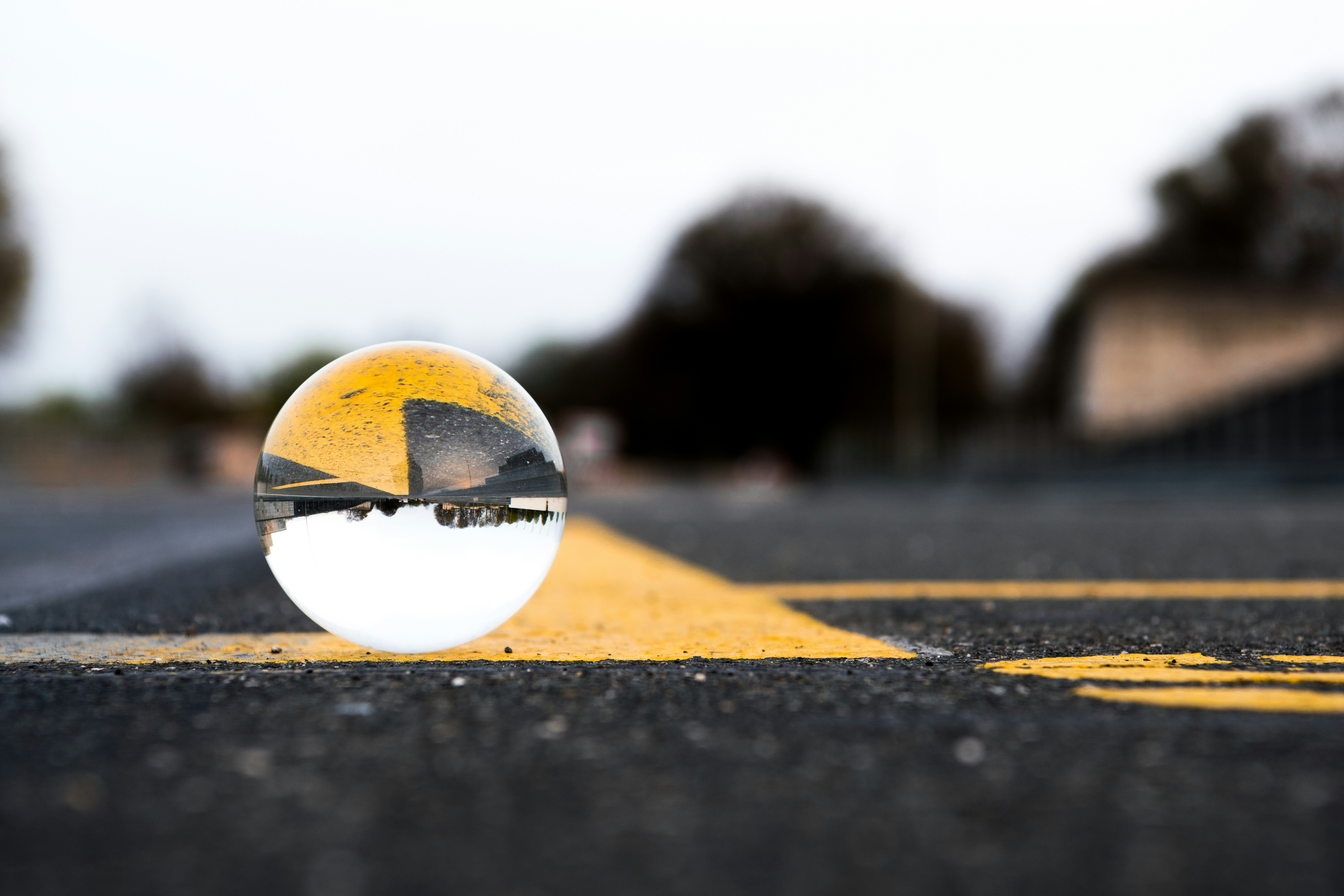 Glass Sphere on a Painted Road: A Moment of Reflections