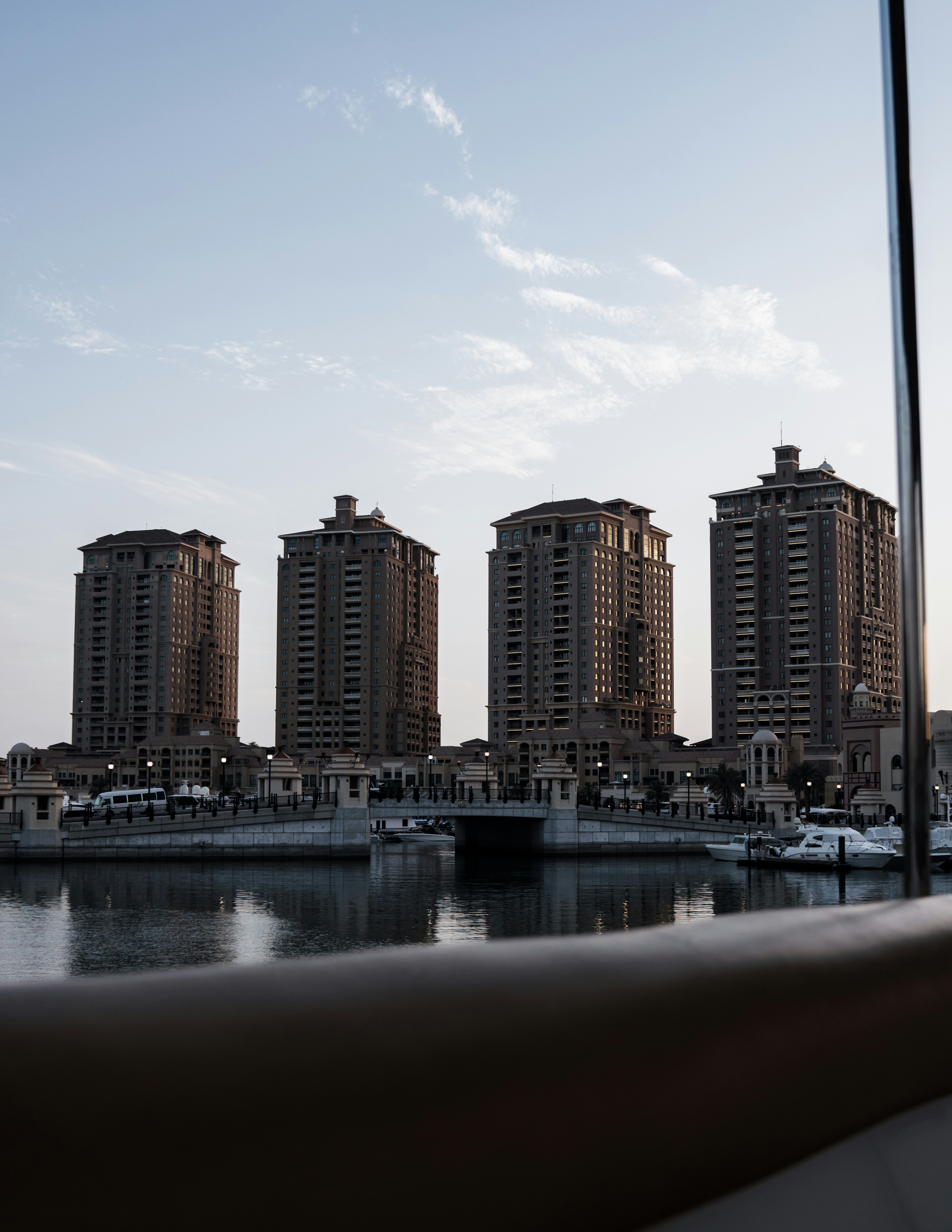 Harbor Towers at Dusk: A Waterfront Vista Framed by a Boat Window