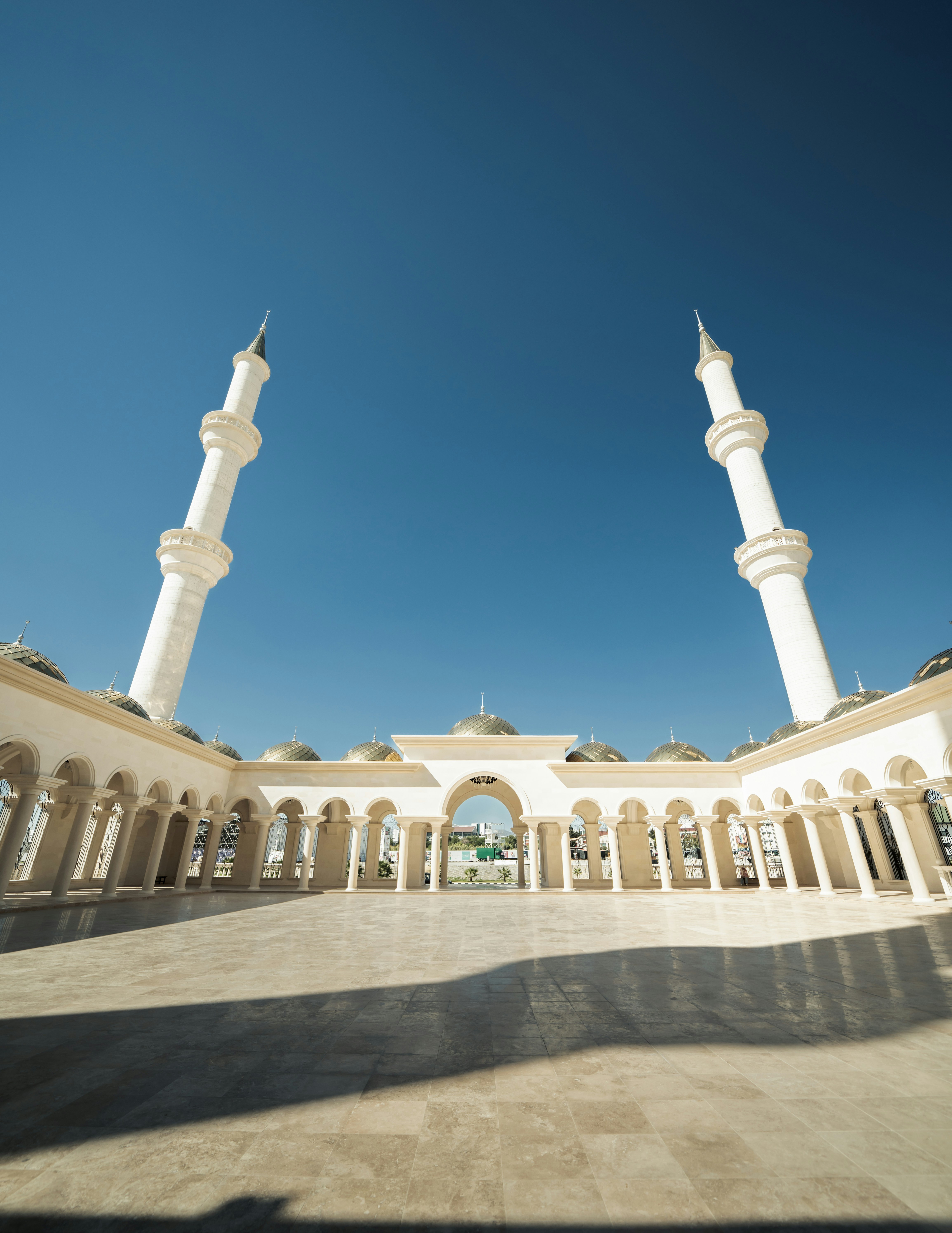 Courtyard of Light: Minarets Framing a Clear Sky
