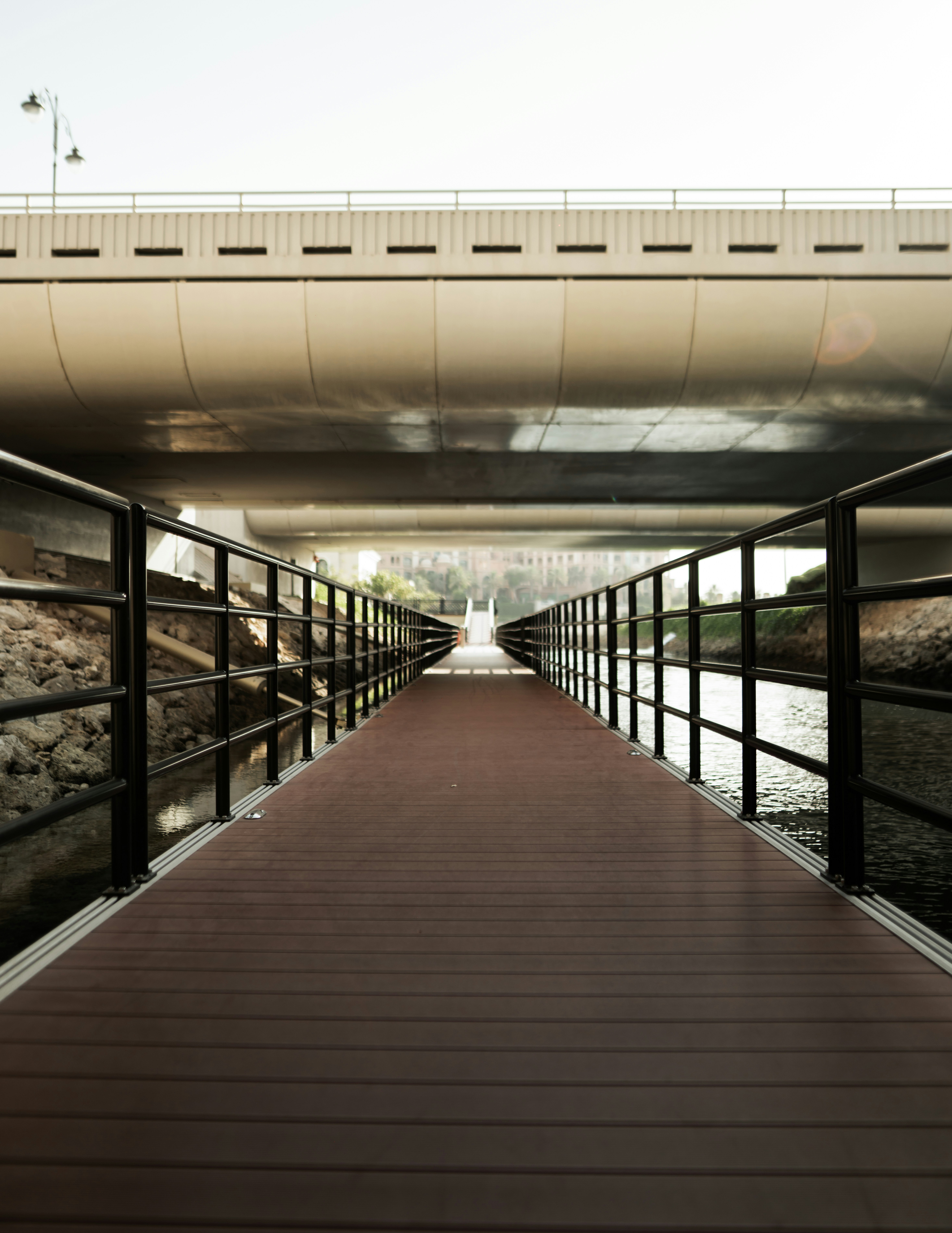 Underpass Pathway: A Tunnel of Rails and Light
