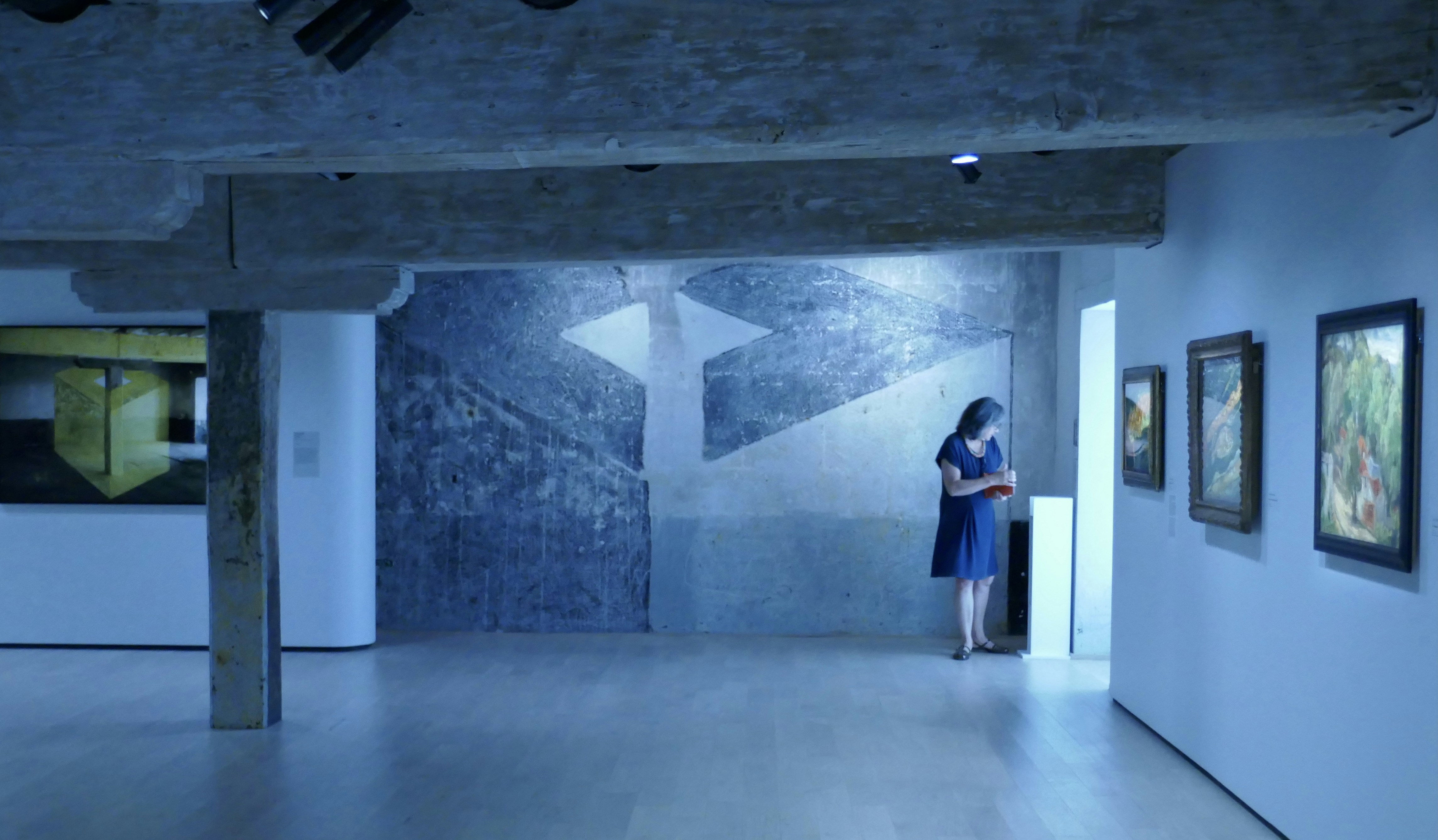 Gallery Quiet: A Woman in Indigo in an Industrial-Blue Corridor