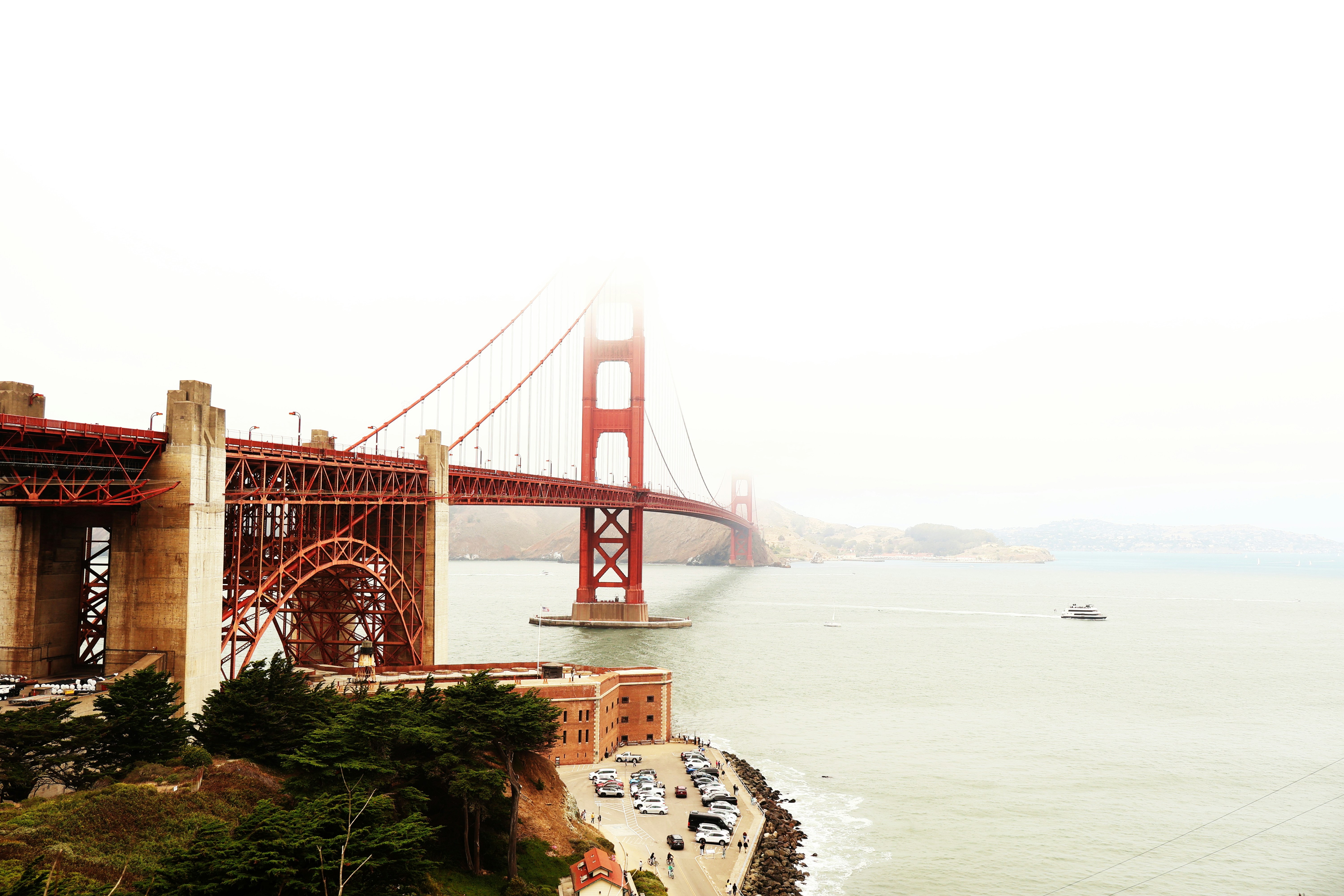 A scenic view of the Golden Gate Bridge overlooking San Francisco Bay on a bright, misty day