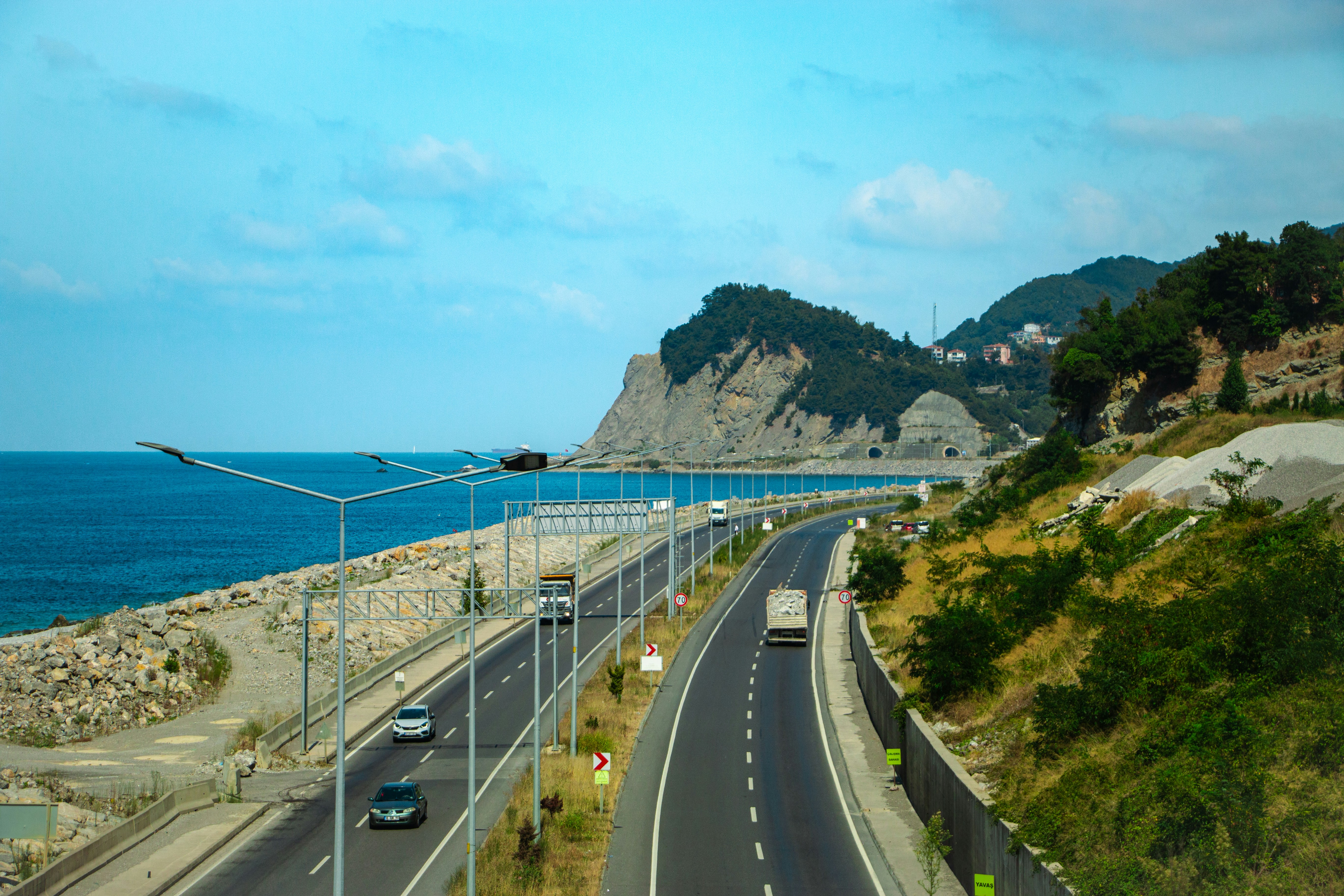 Coastal Highway Bends Along Cliffline Under a Bright Sky