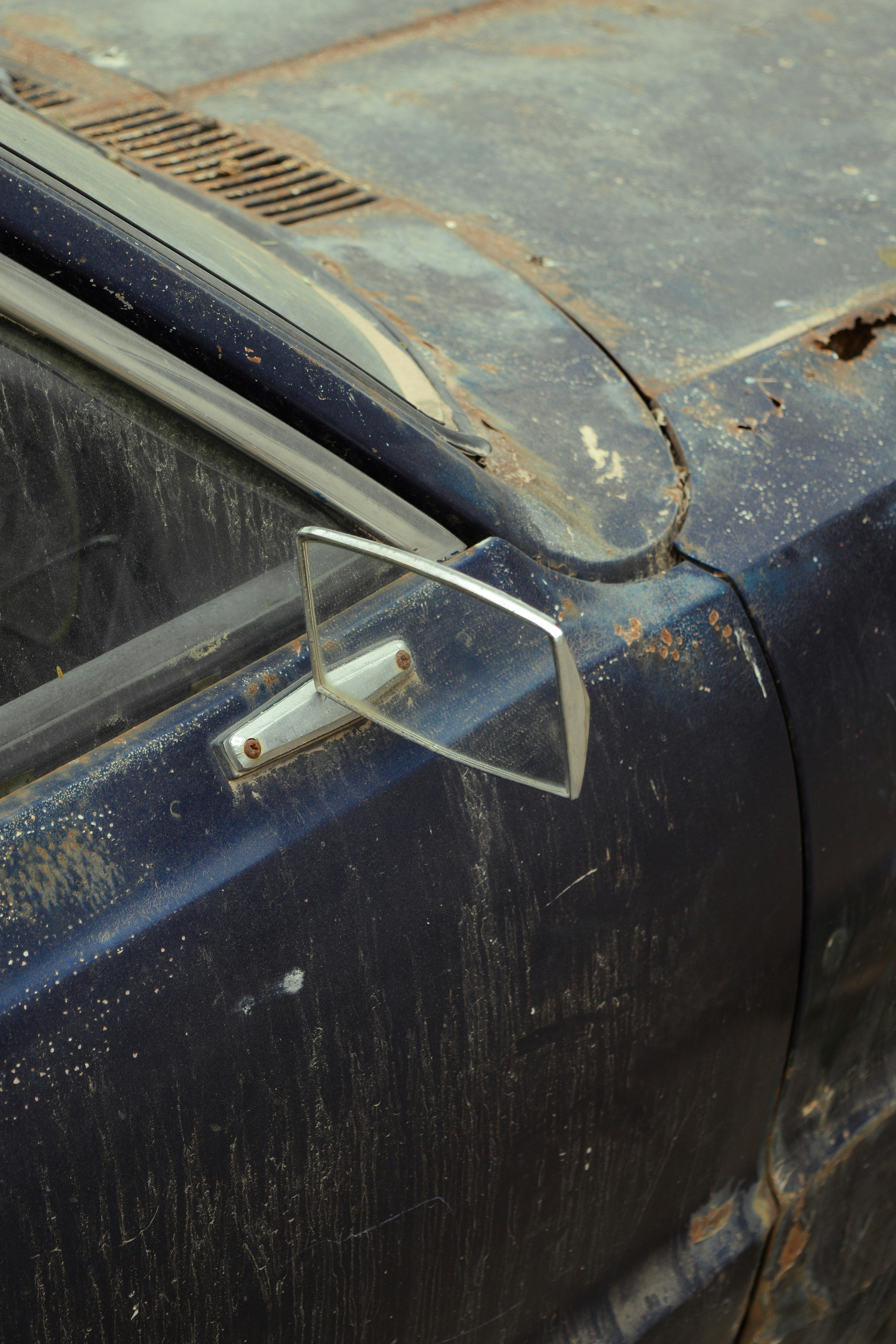 Rust and Reflection: The Side View Mirror of a Weathered Classic