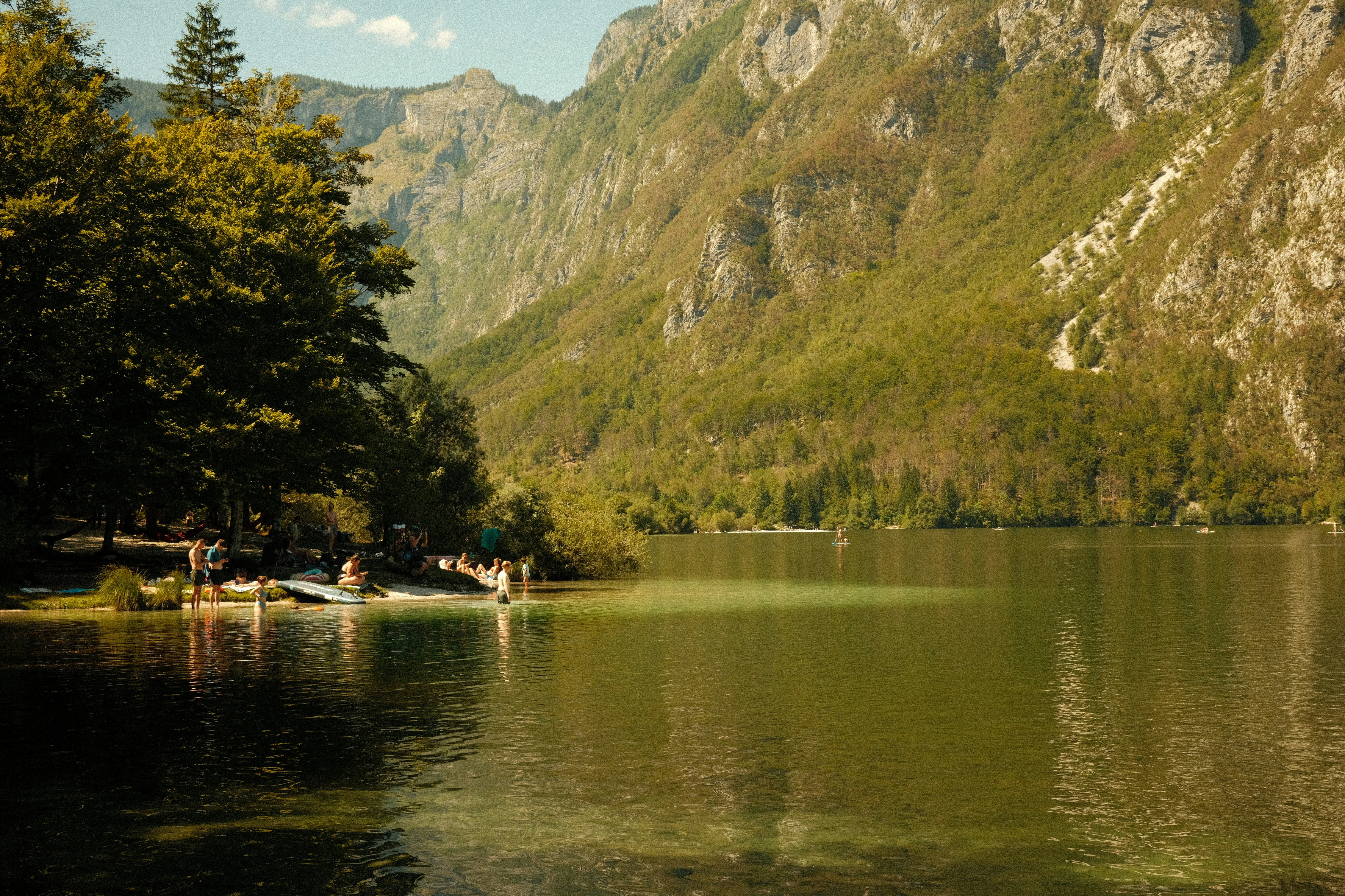 Riverbank Rendezvous: Kayaks and Distant Peaks Melt into Emerald Silence